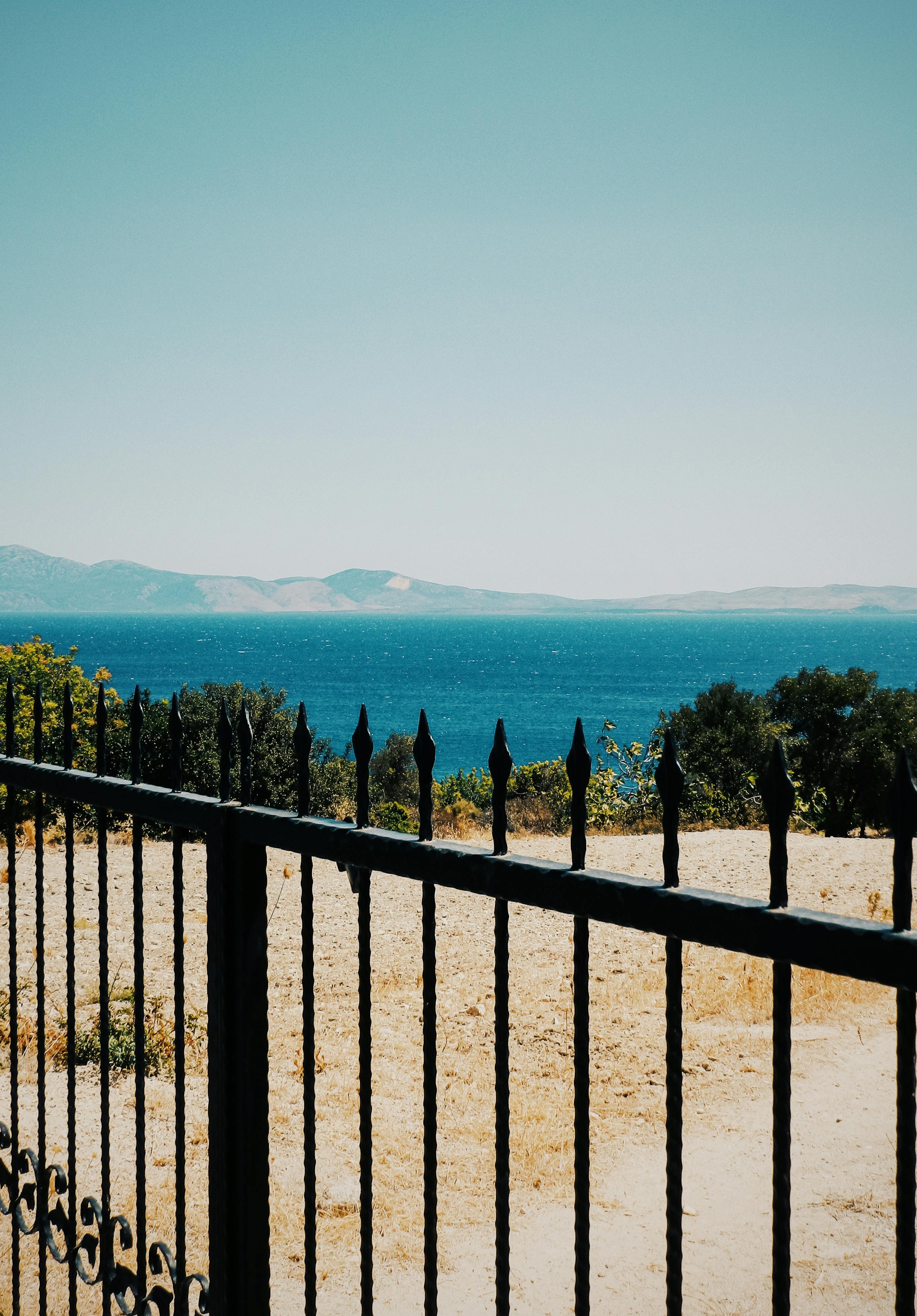 Metal Fence Overlooking View of the Beach · Free Stock Photo
