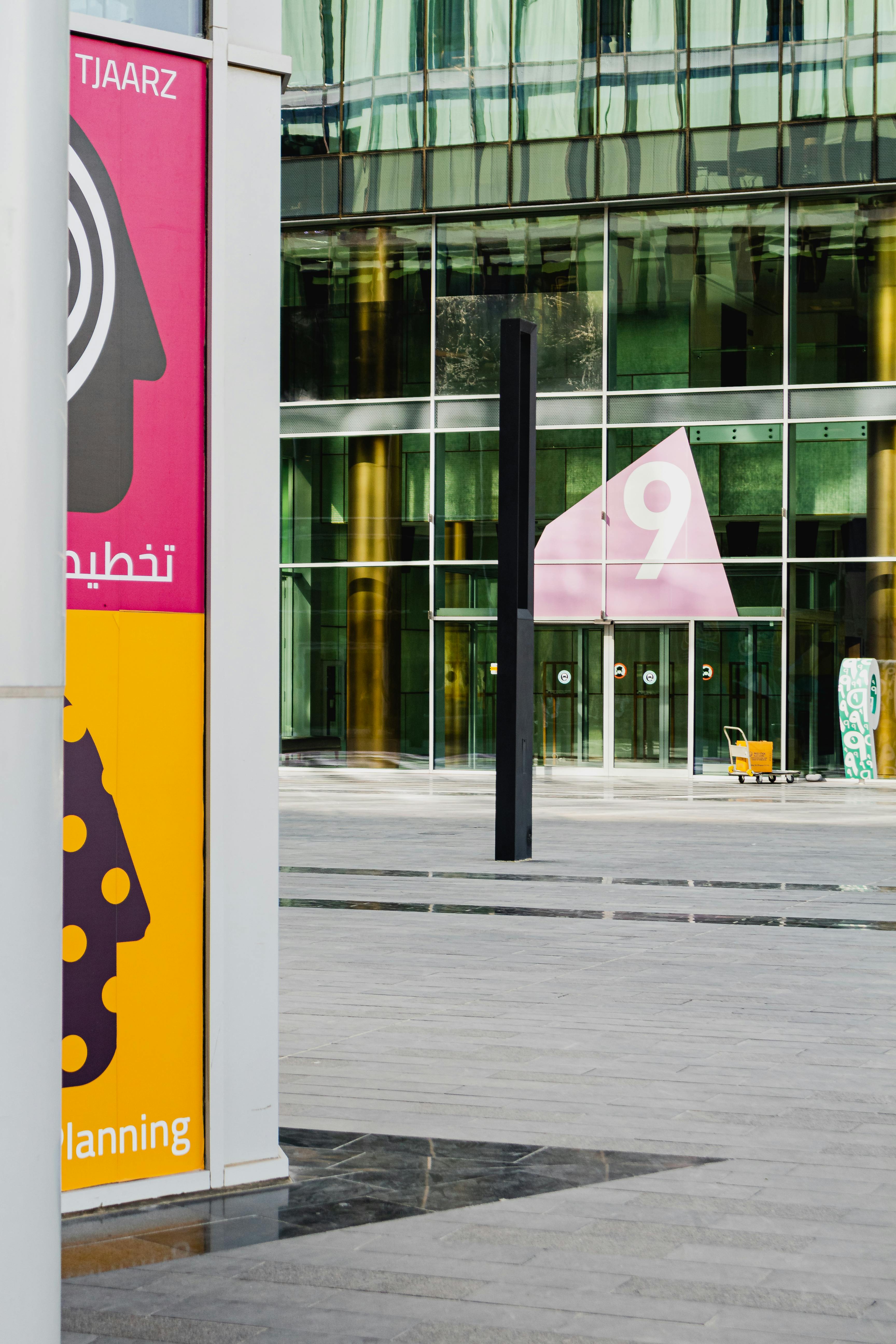Entrance to Glass Building Seen from Bus Stop · Free Stock Photo