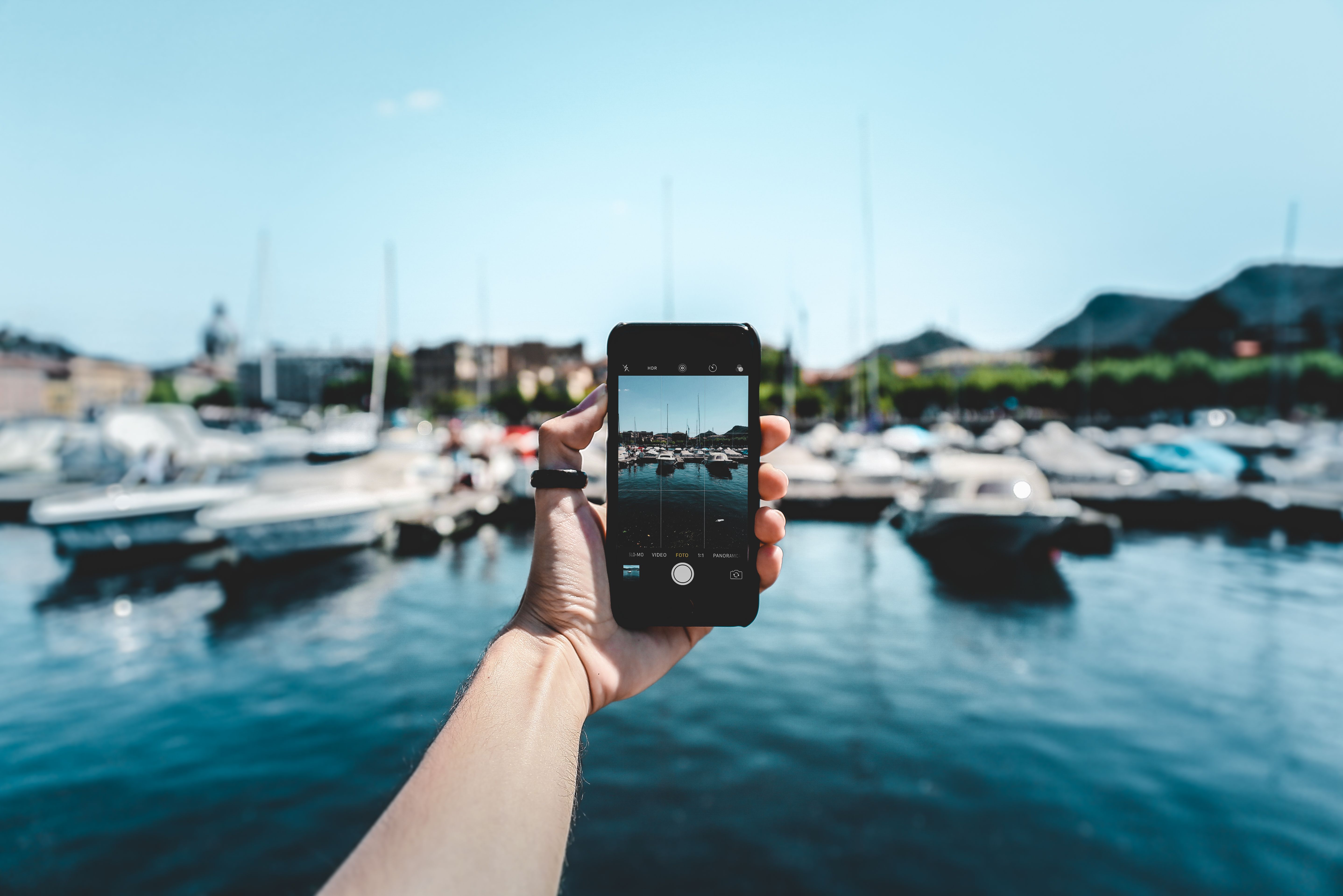 Person Holding a Smart Phone and Photographing People Walking on the ...