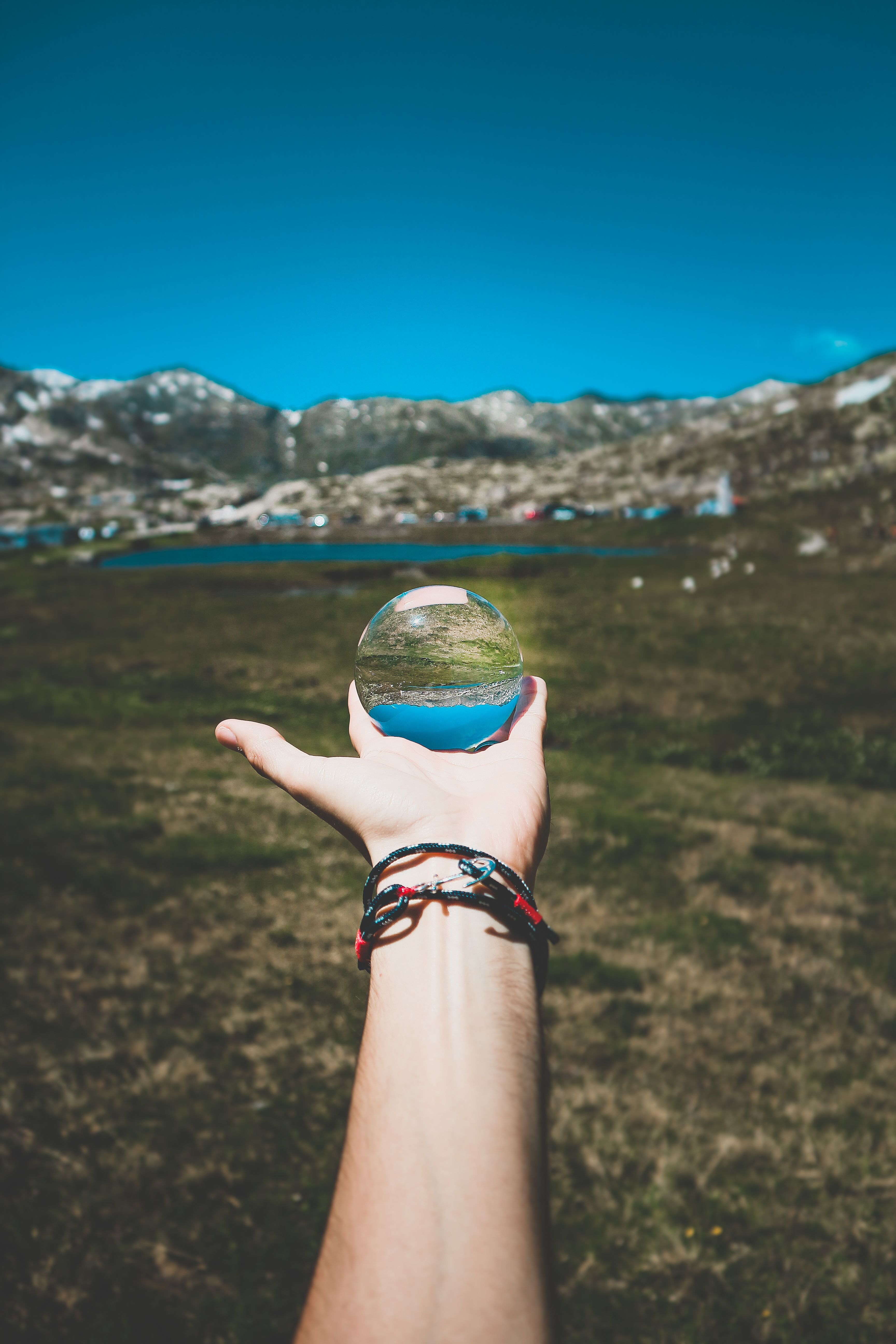 Person Holding Clear Glass Ball · Free Stock Photo