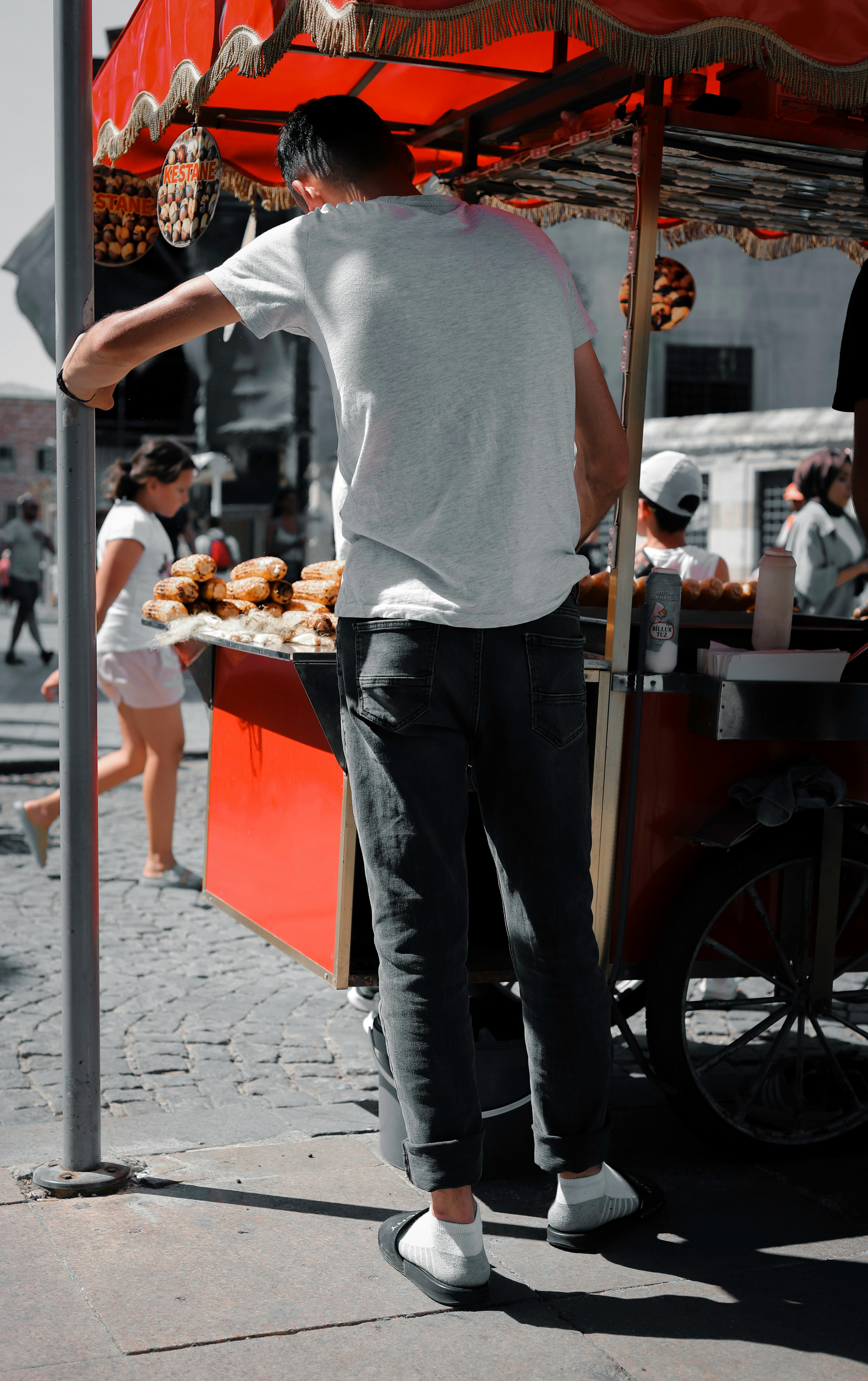 A Street Vendor Selling Street Food · Free Stock Photo