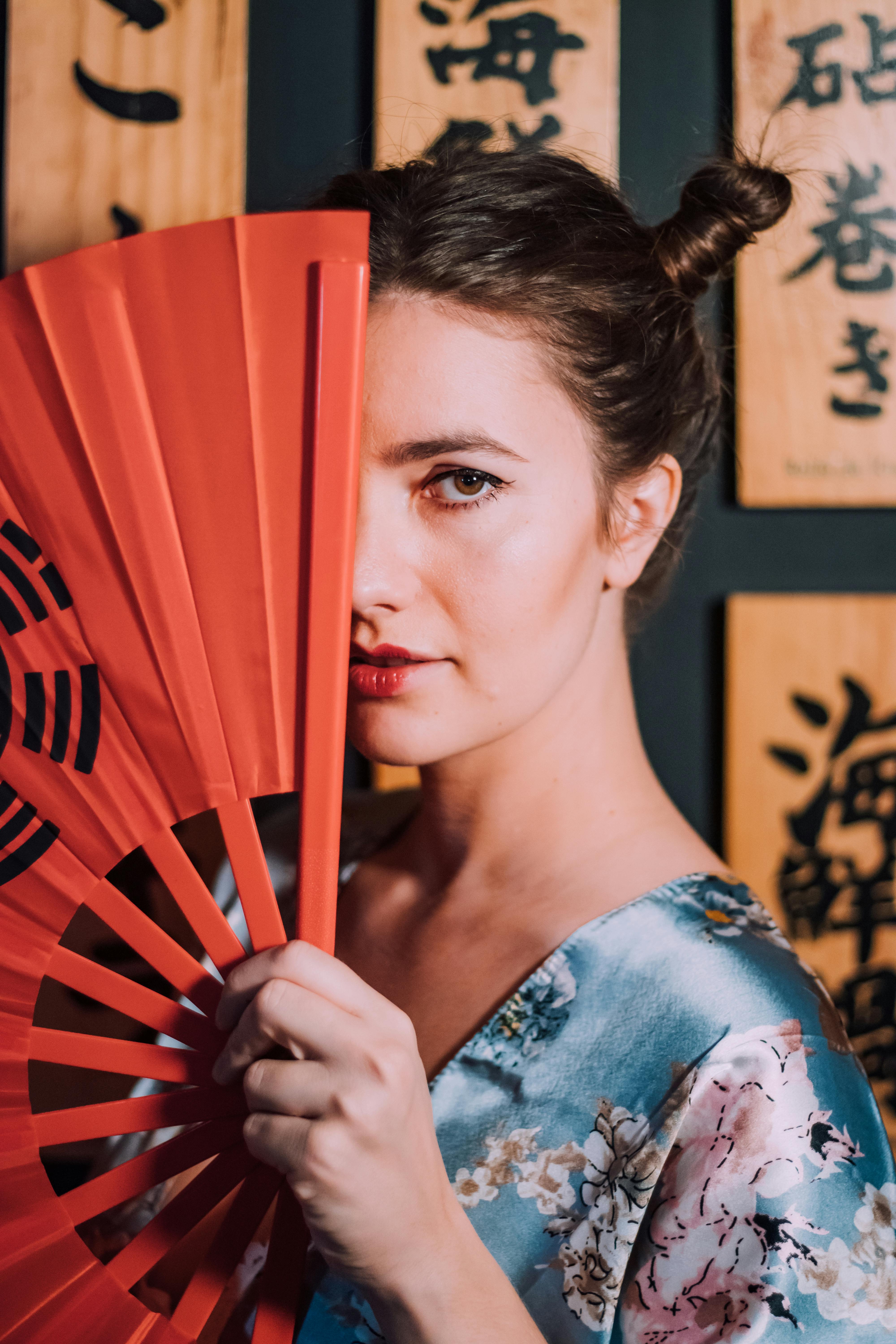 Woman Covering Her Face with Hand Fan · Free Stock Photo
