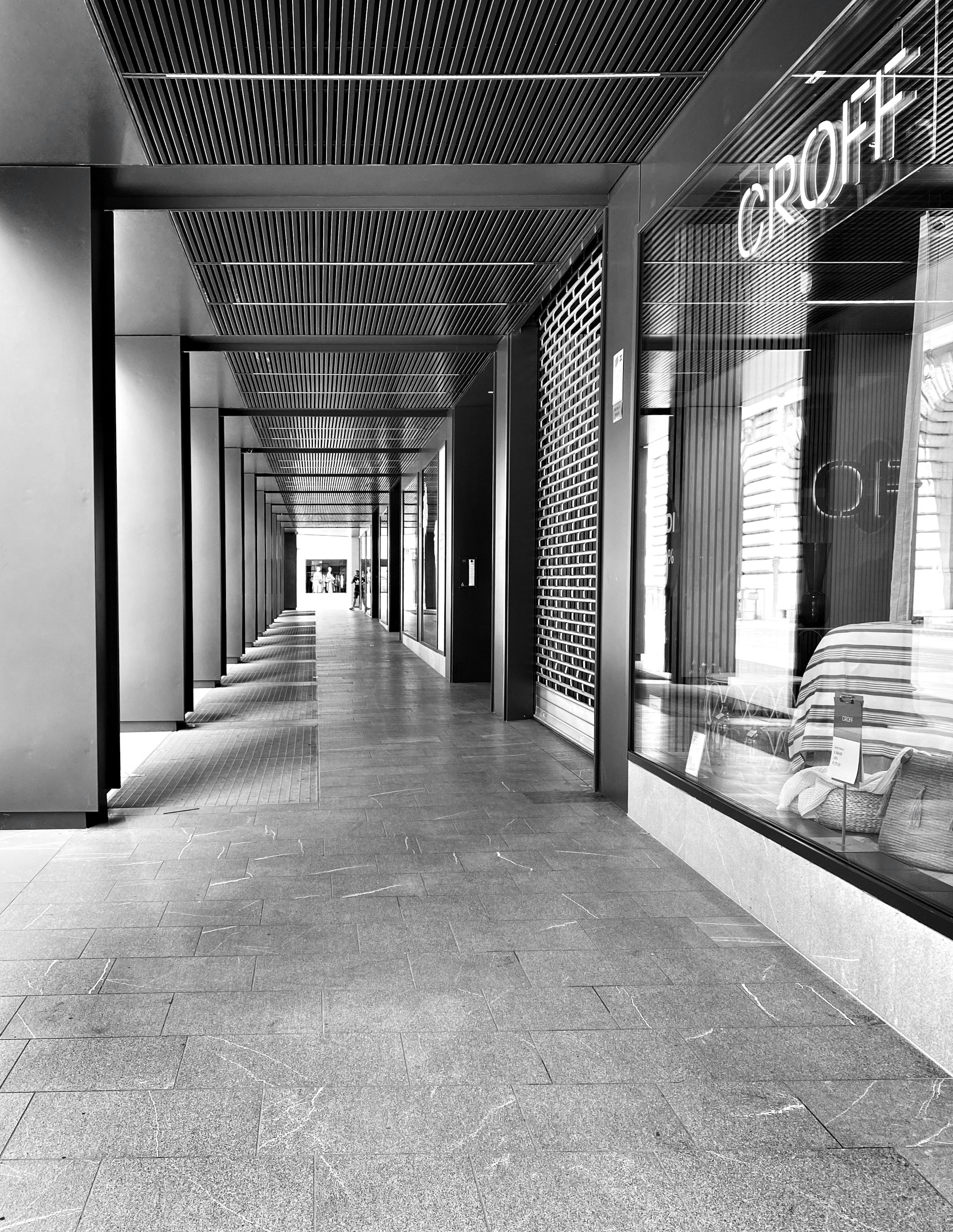 A Grayscale of a Hallway of a Building · Free Stock Photo