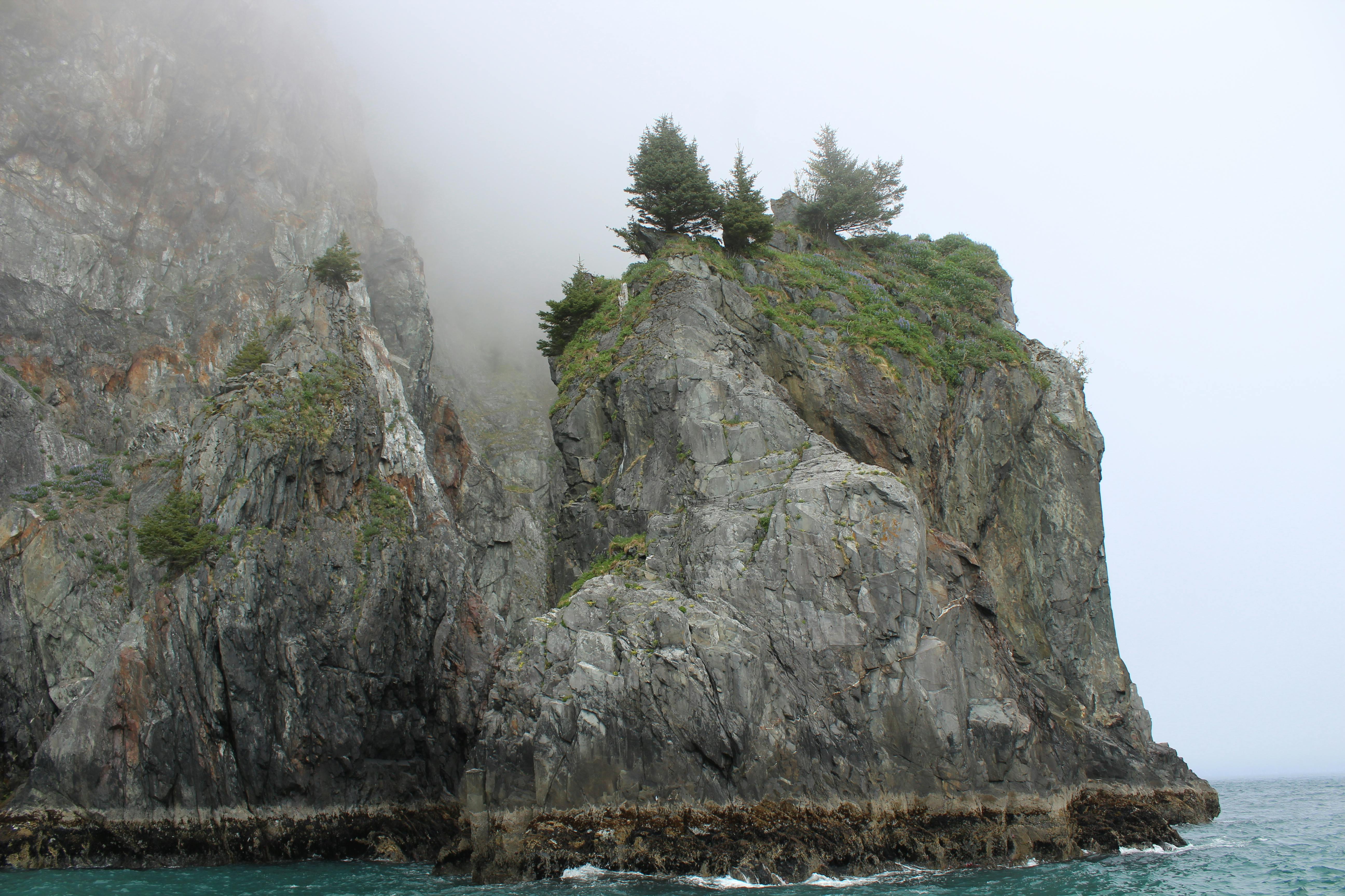 Gray Rocky Mountain Beside the Ocean · Free Stock Photo