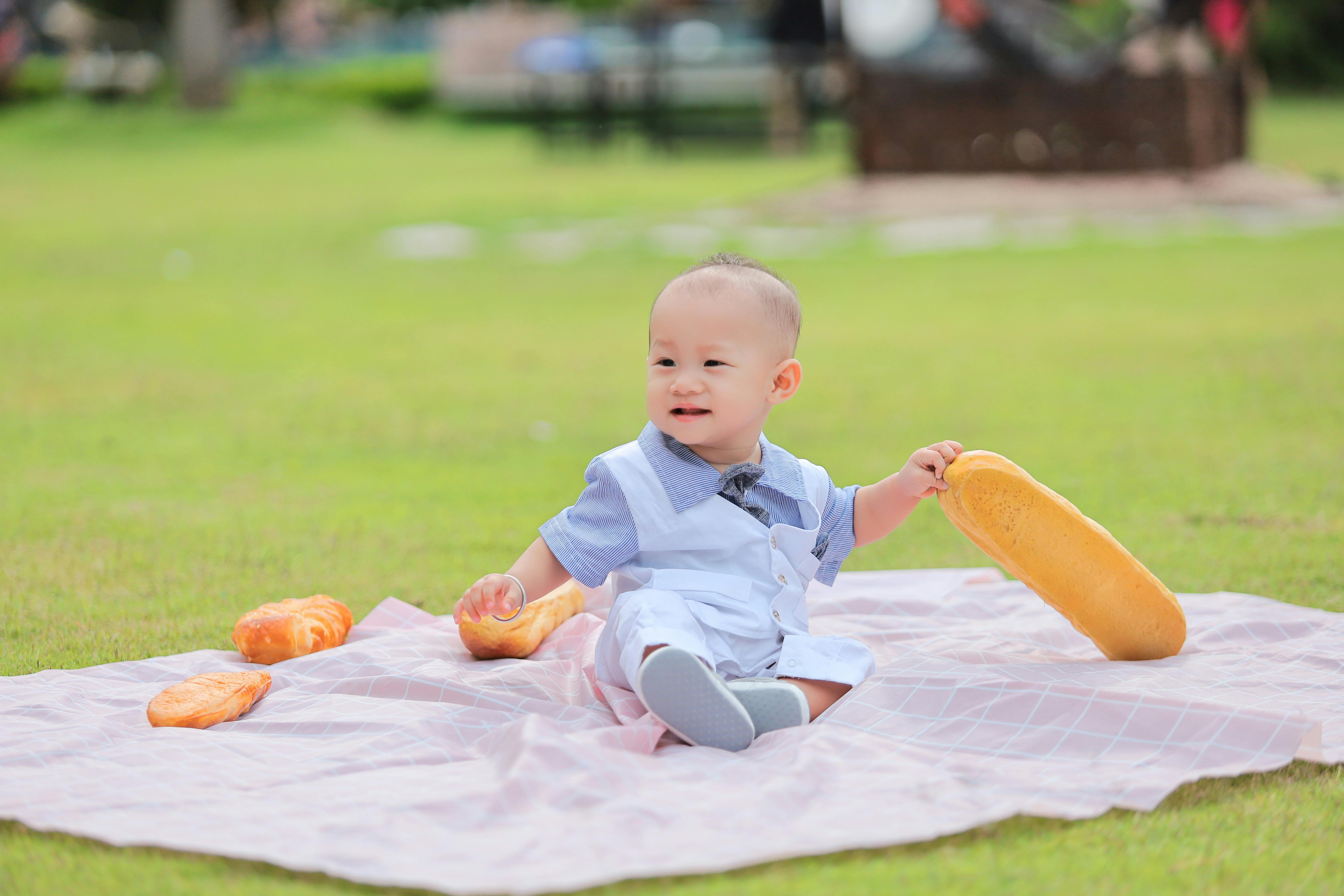 Photo of a Boy Holding a Loaf of Bread · Free Stock Photo