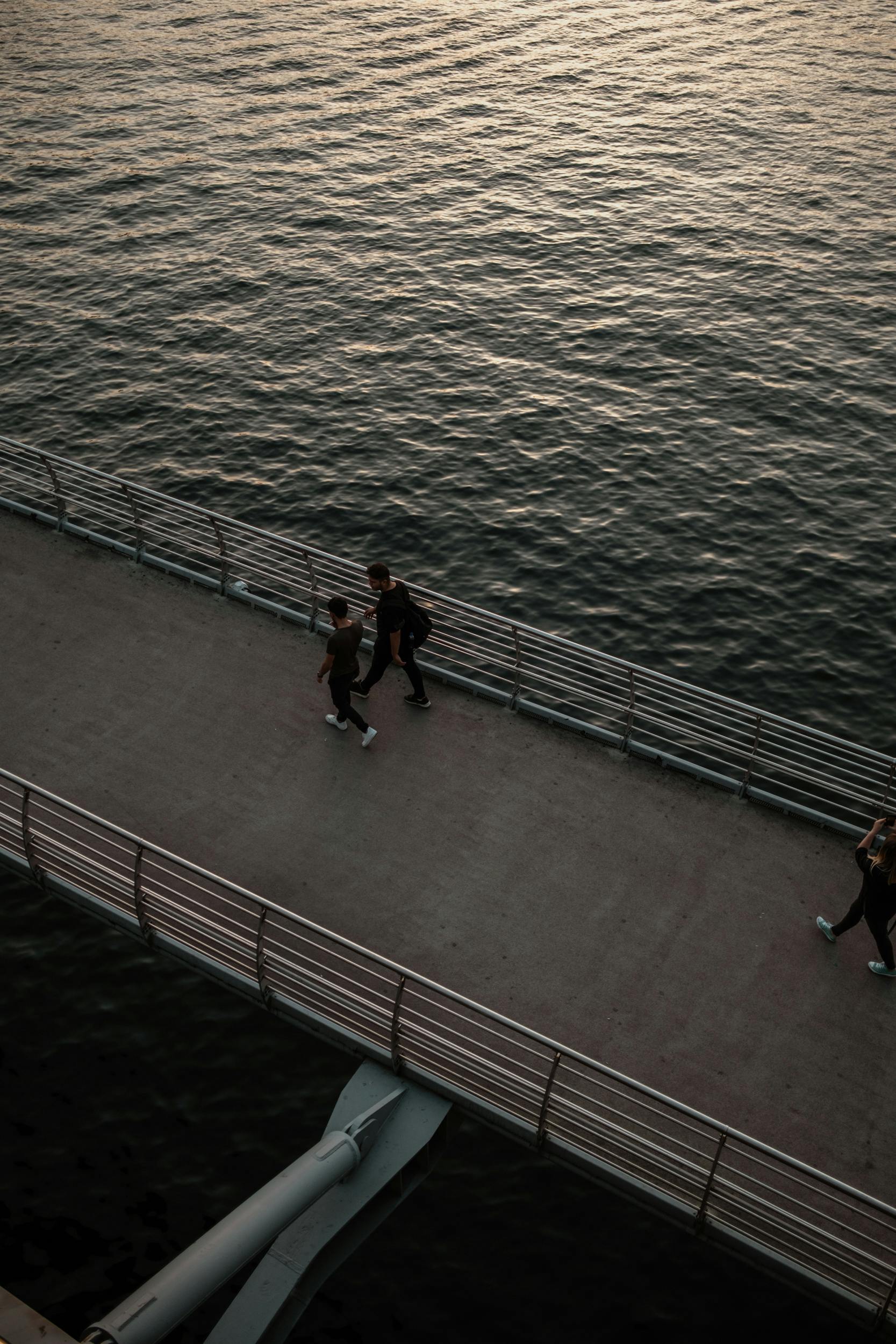 People Walking on Concrete Bridge · Free Stock Photo