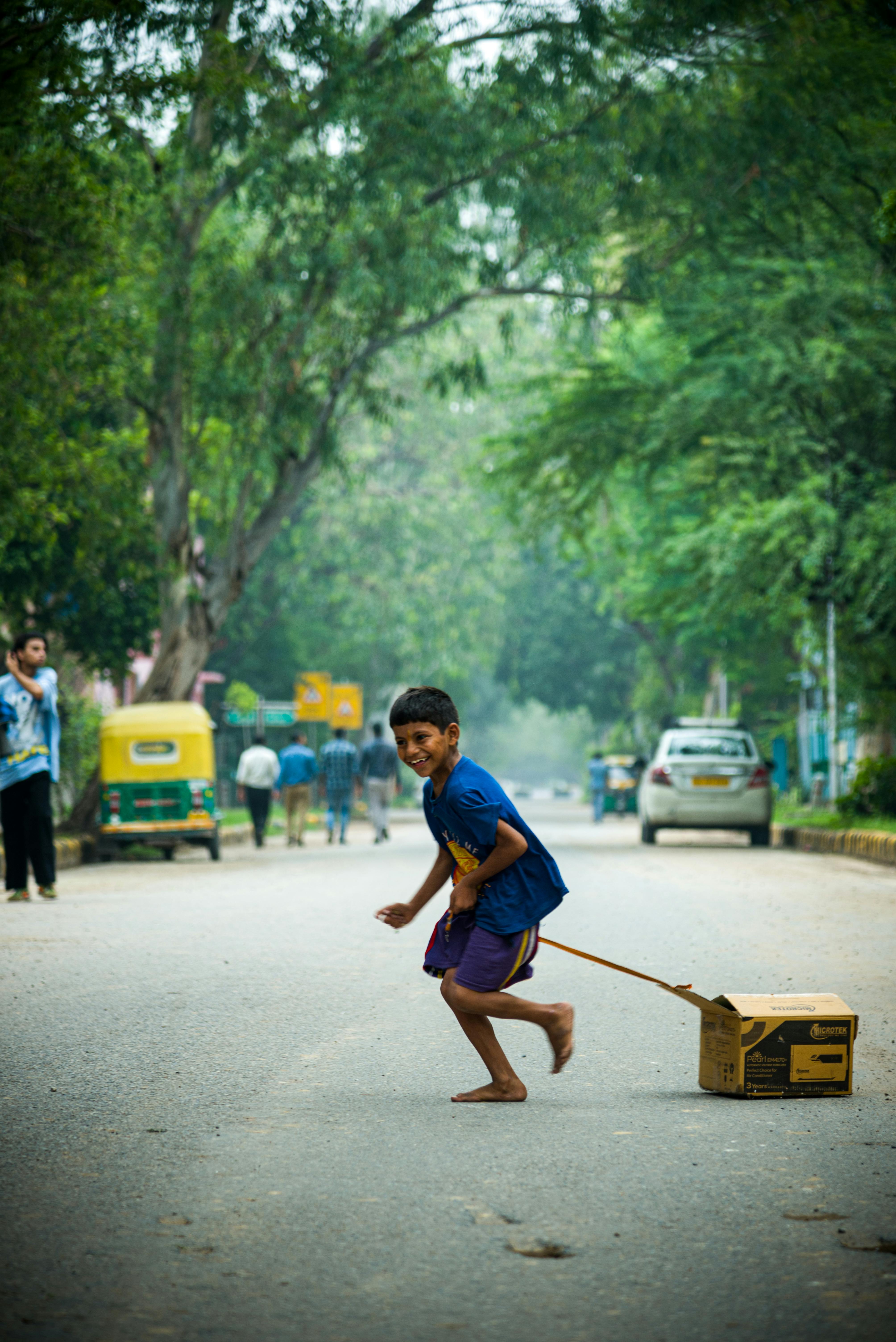 A Boy Pulling a Box · Free Stock Photo
