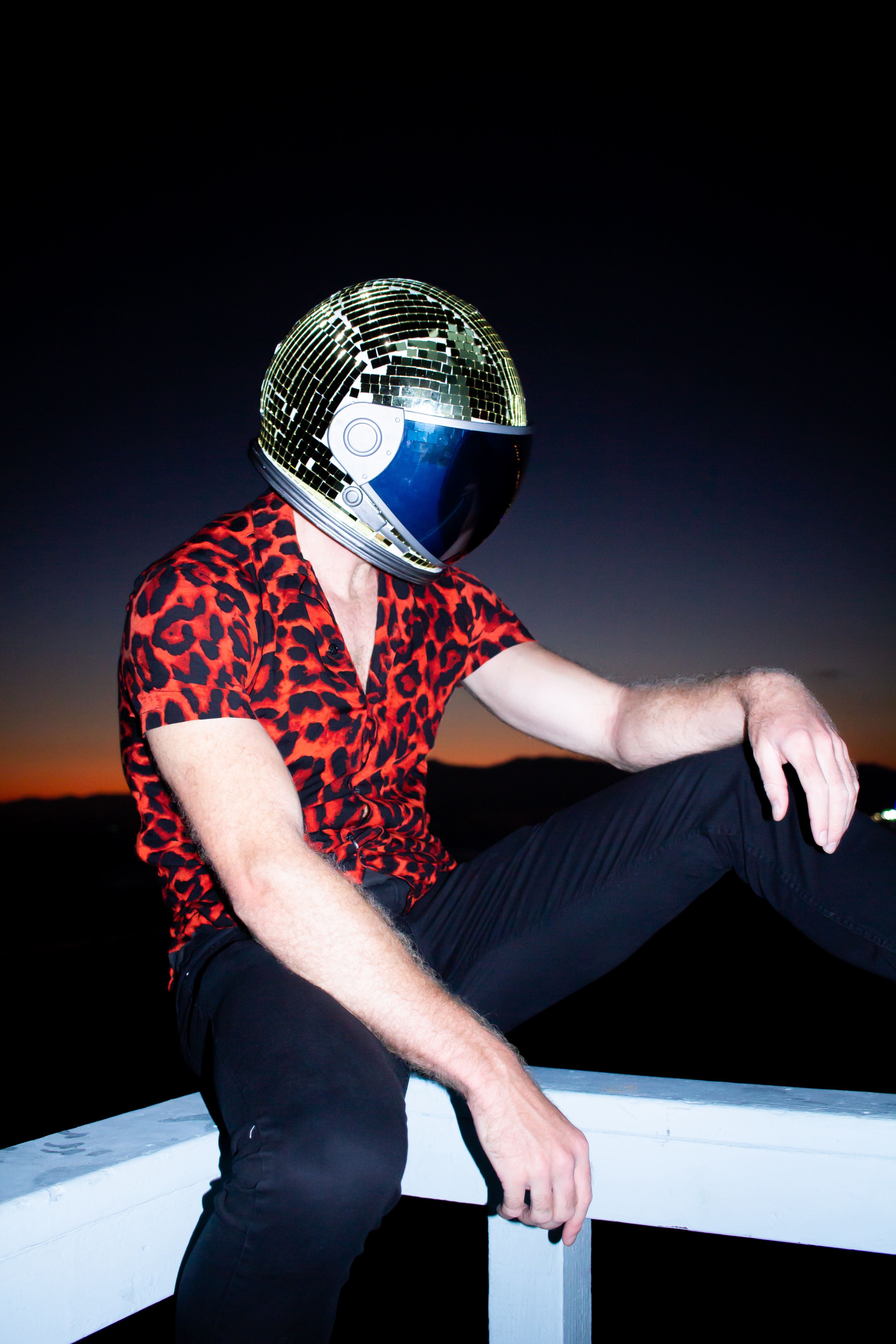 A Person Wearing Helmet while Sitting on a Wooden Railing · Free Stock ...