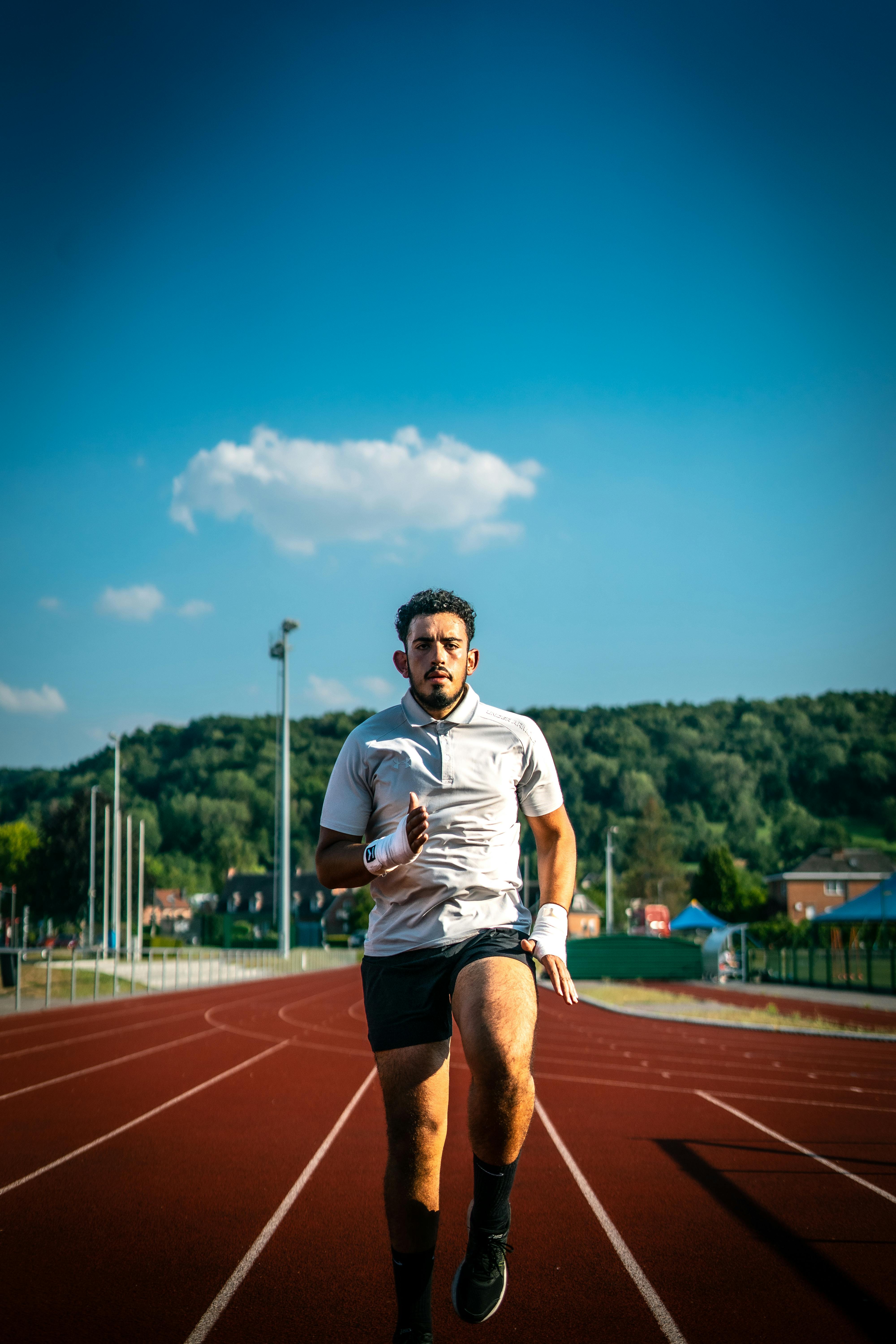 Woman Sitting on a Running Track · Free Stock Photo