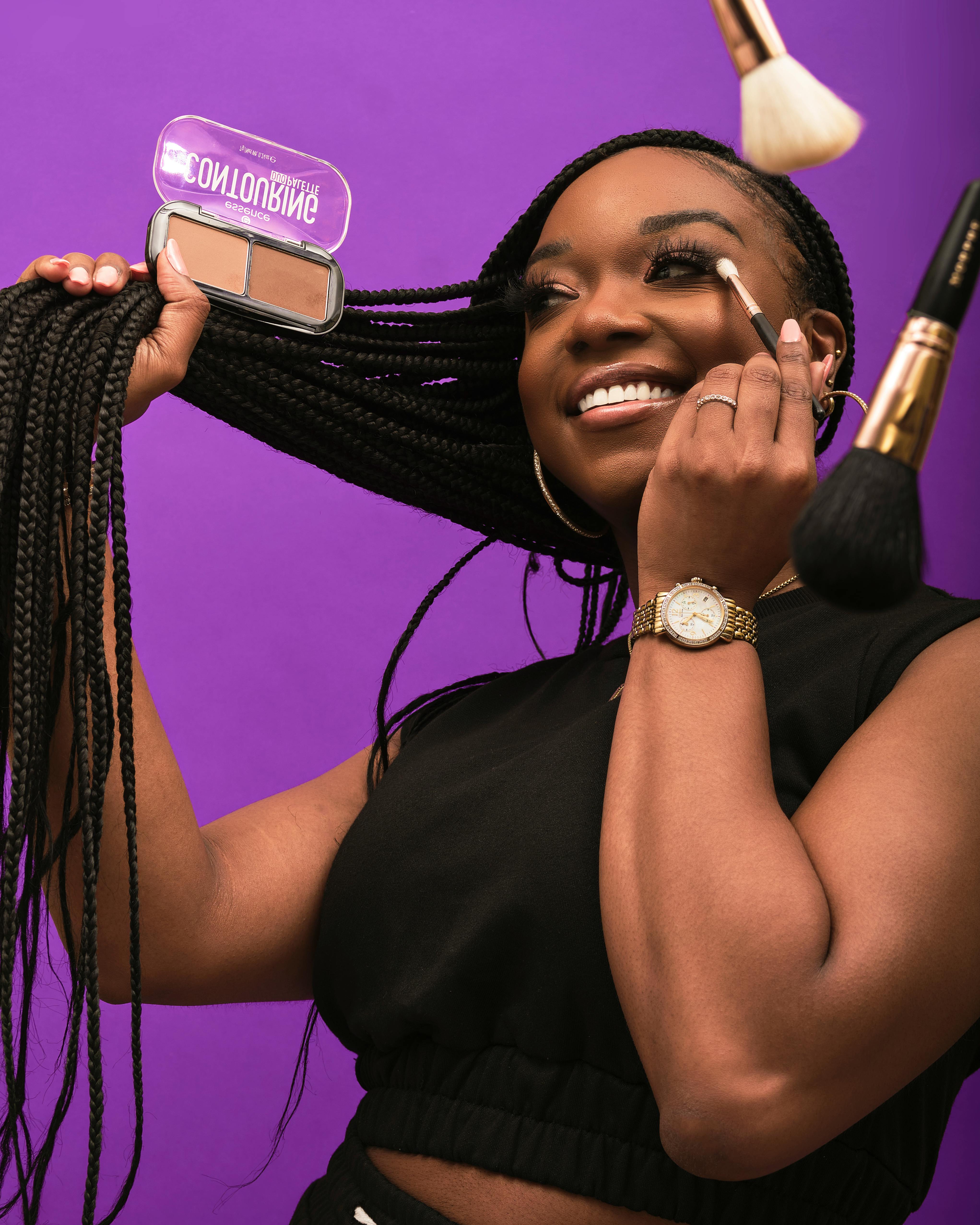 Woman in Black Top Holding Her Afro Braided Hair while Doing Her Make ...