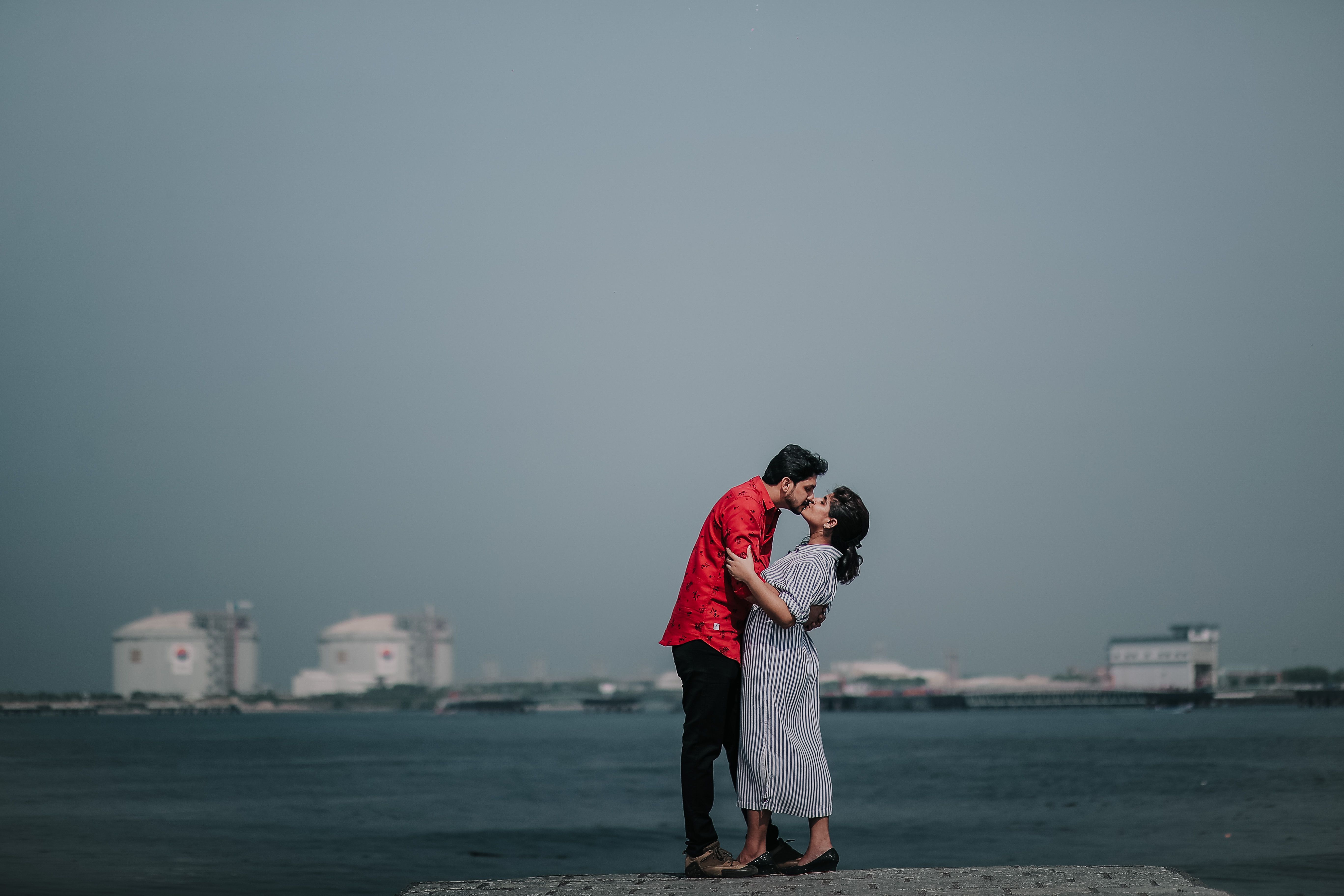 Romantic Couple Kissing while Holding Hands · Free Stock Photo