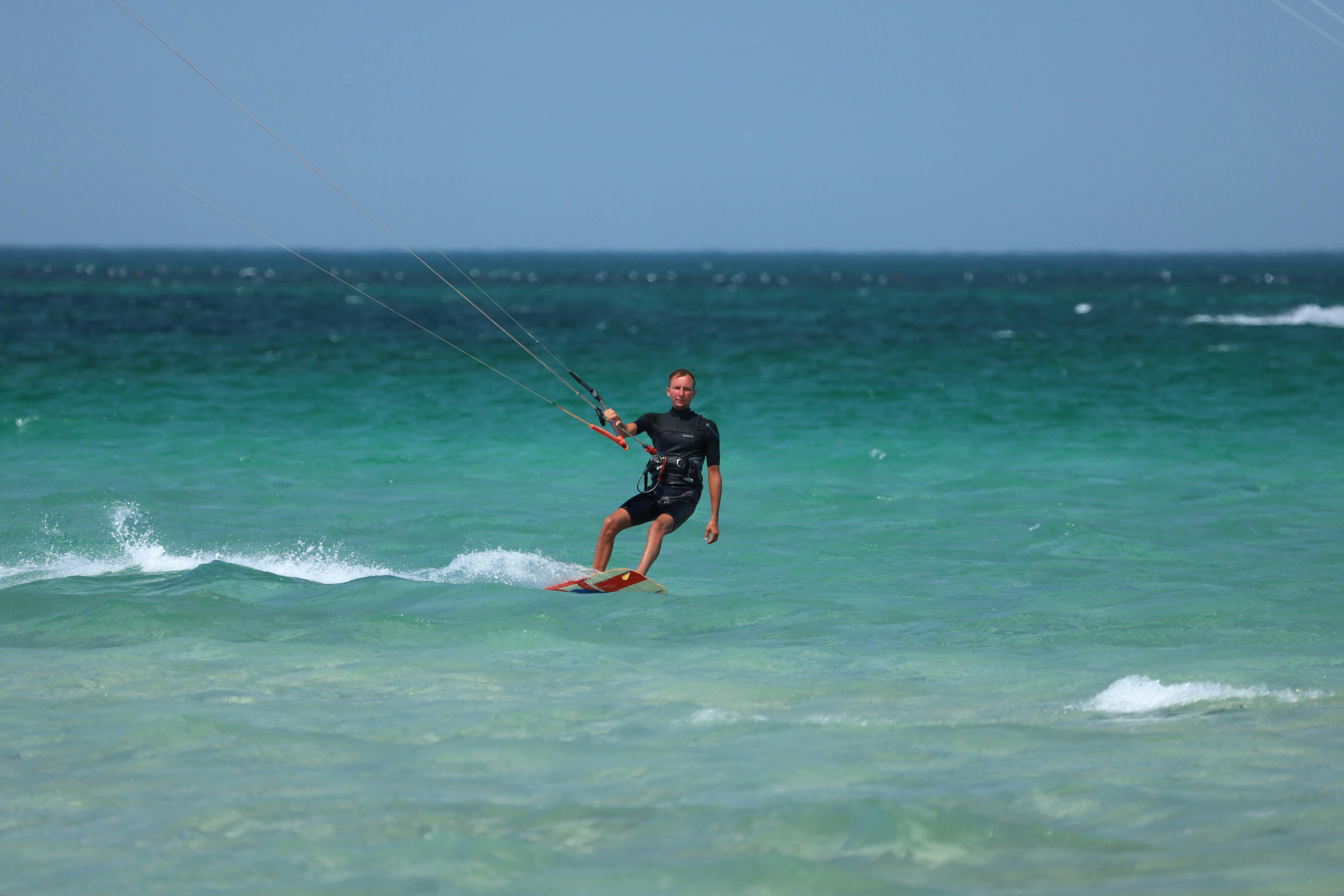 Person on Body of Water Kitesurfing · Free Stock Photo