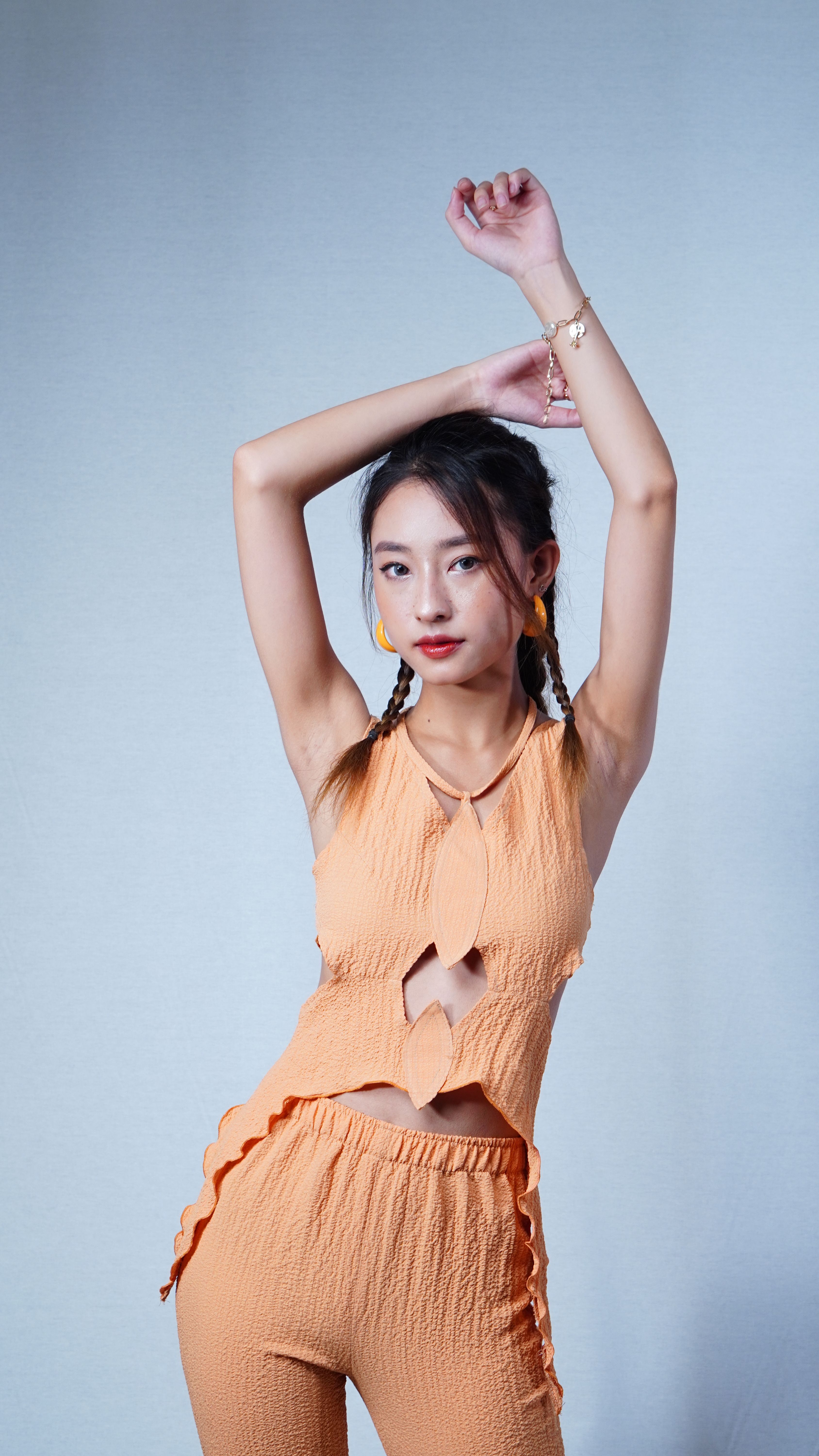 A Woman Wearing an Orange Co-Ord Set · Free Stock Photo