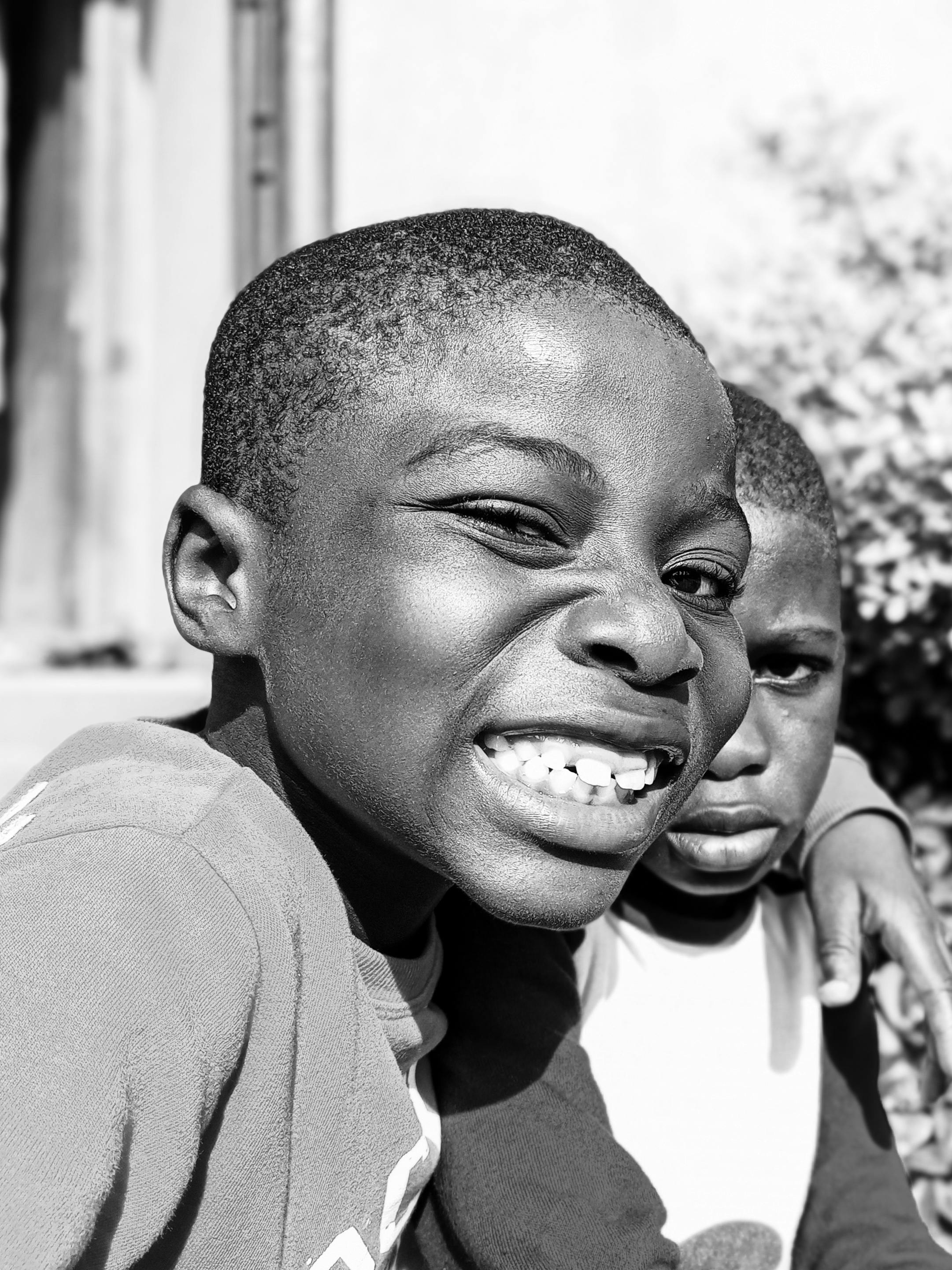 Grayscale Photo of Smiling Boy · Free Stock Photo