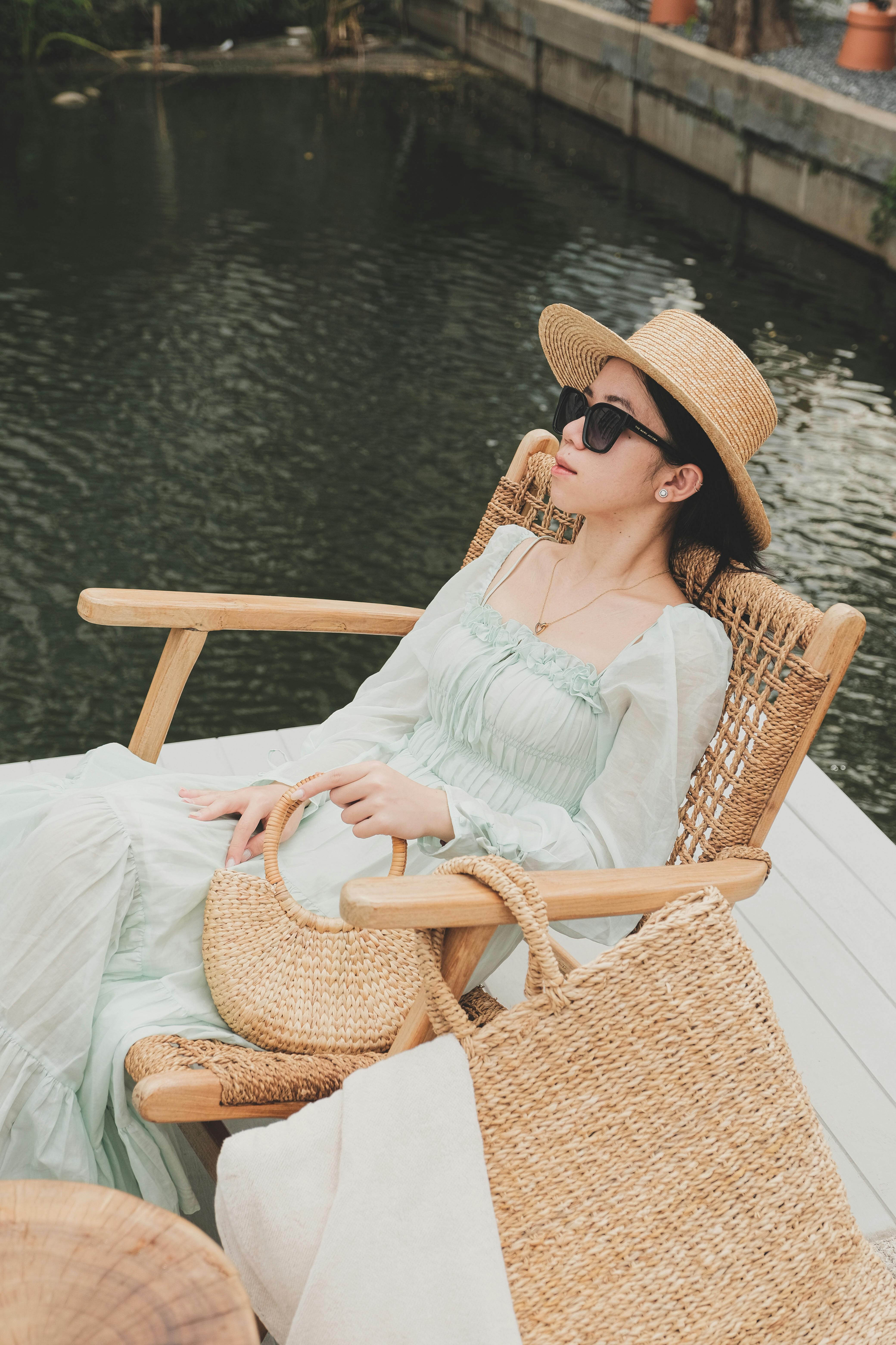 Woman Relaxing, Sitting in Sun in Big Round Hat · Free Stock Photo
