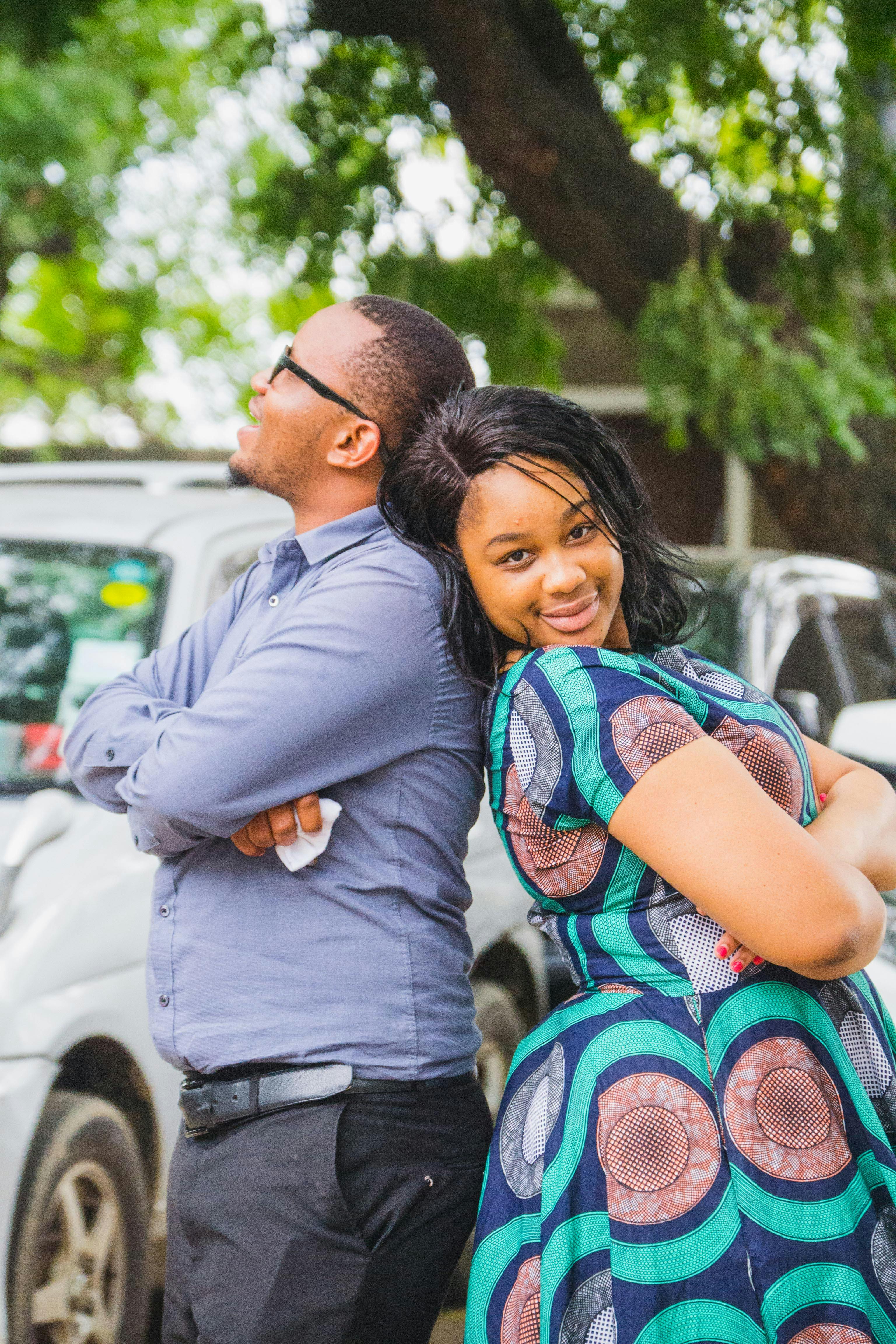 Man and Woman Leaning on Each Other's Back · Free Stock Photo
