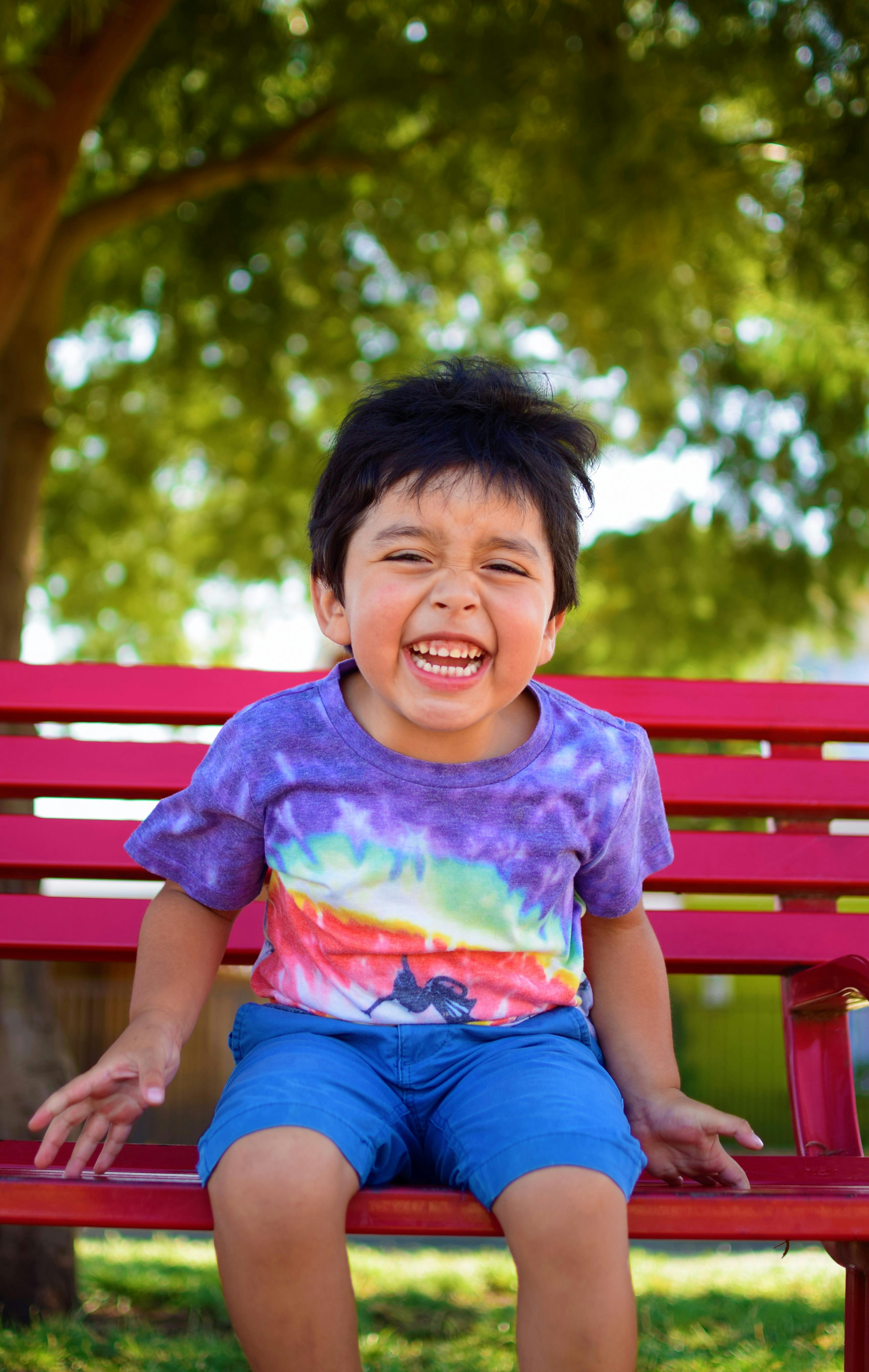 Boy Sitting on a Bench · Free Stock Photo