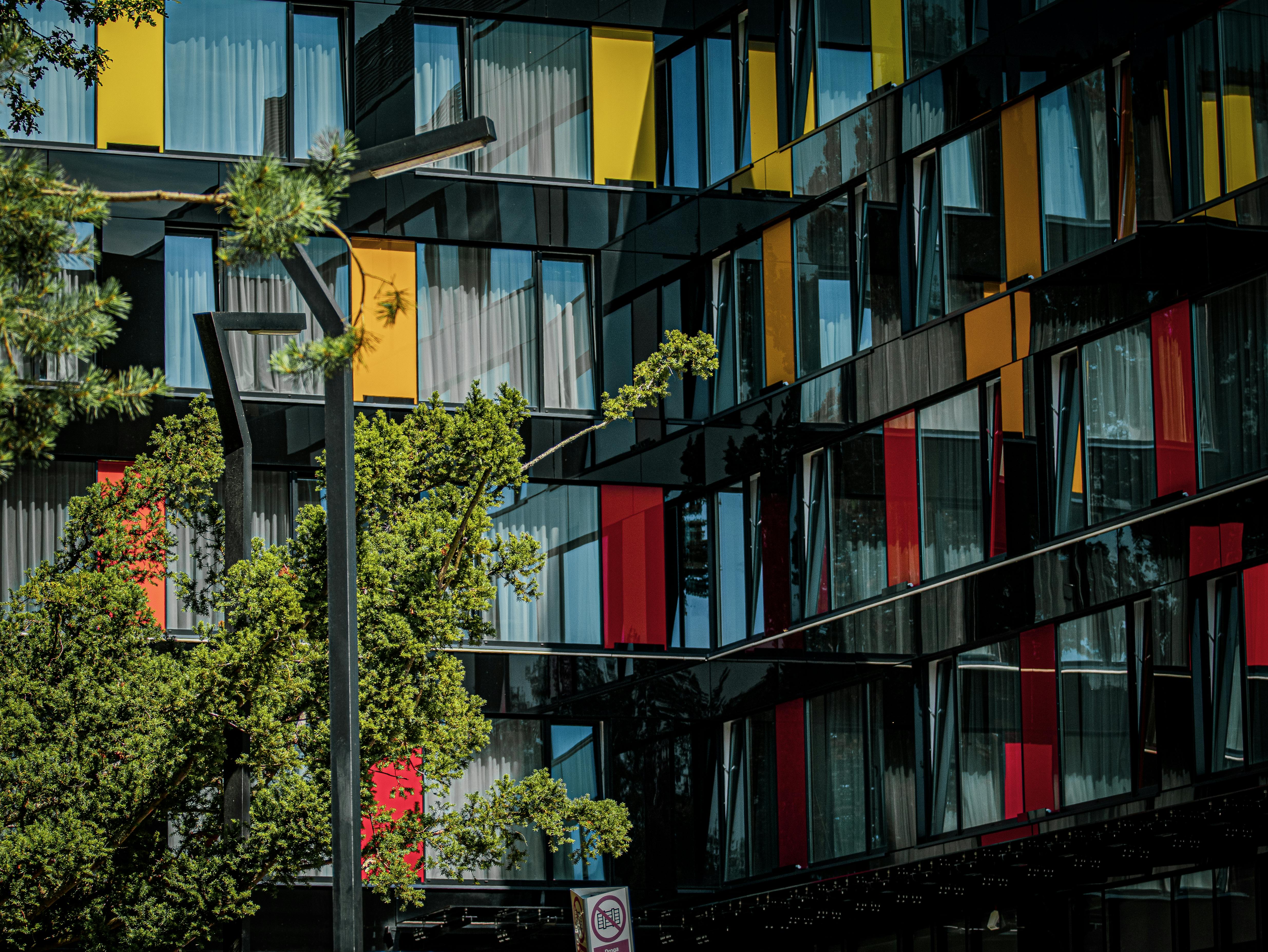 A Red and Yellow Building with Glass Windows · Free Stock Photo