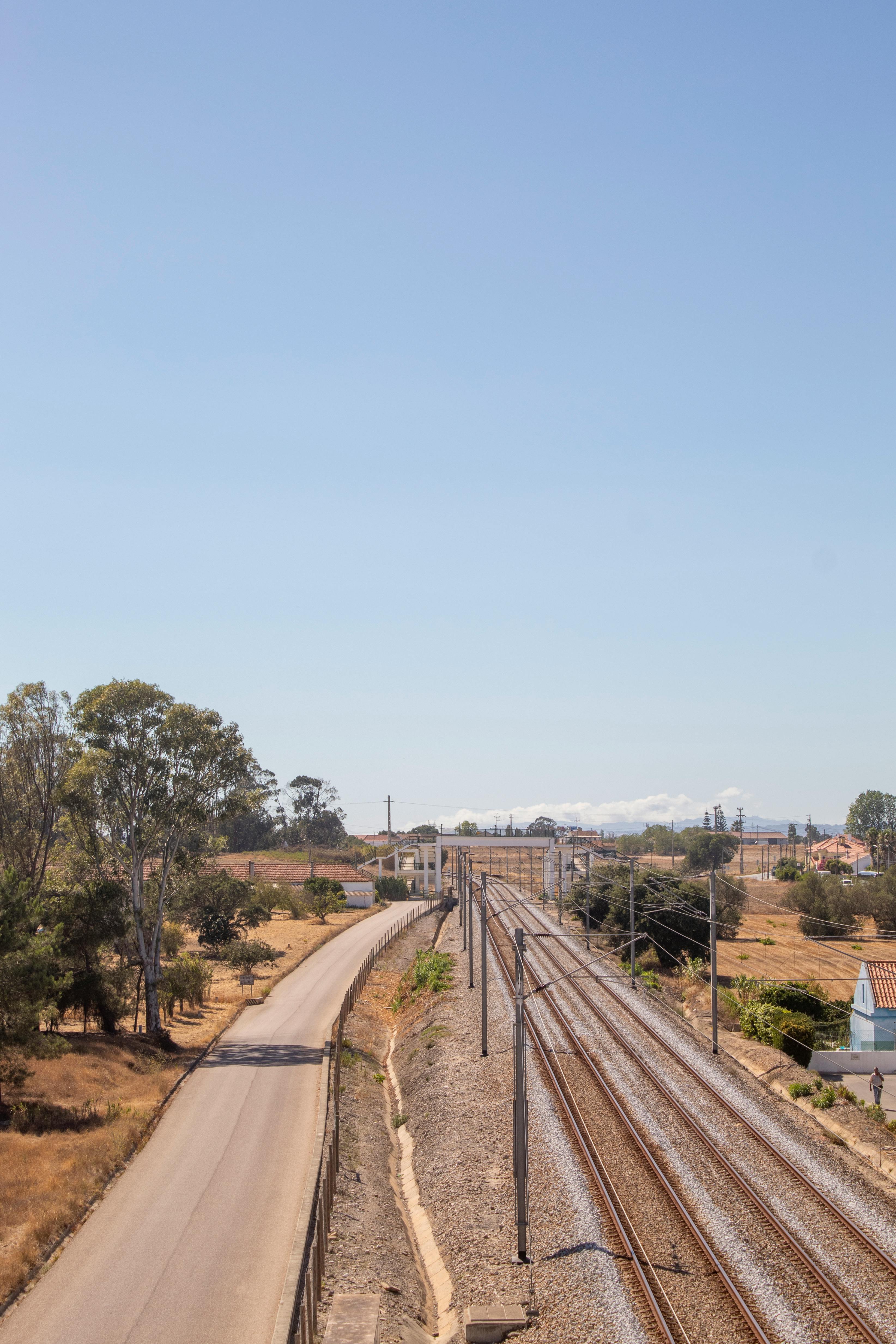 Road Next to Railway Tracks · Free Stock Photo