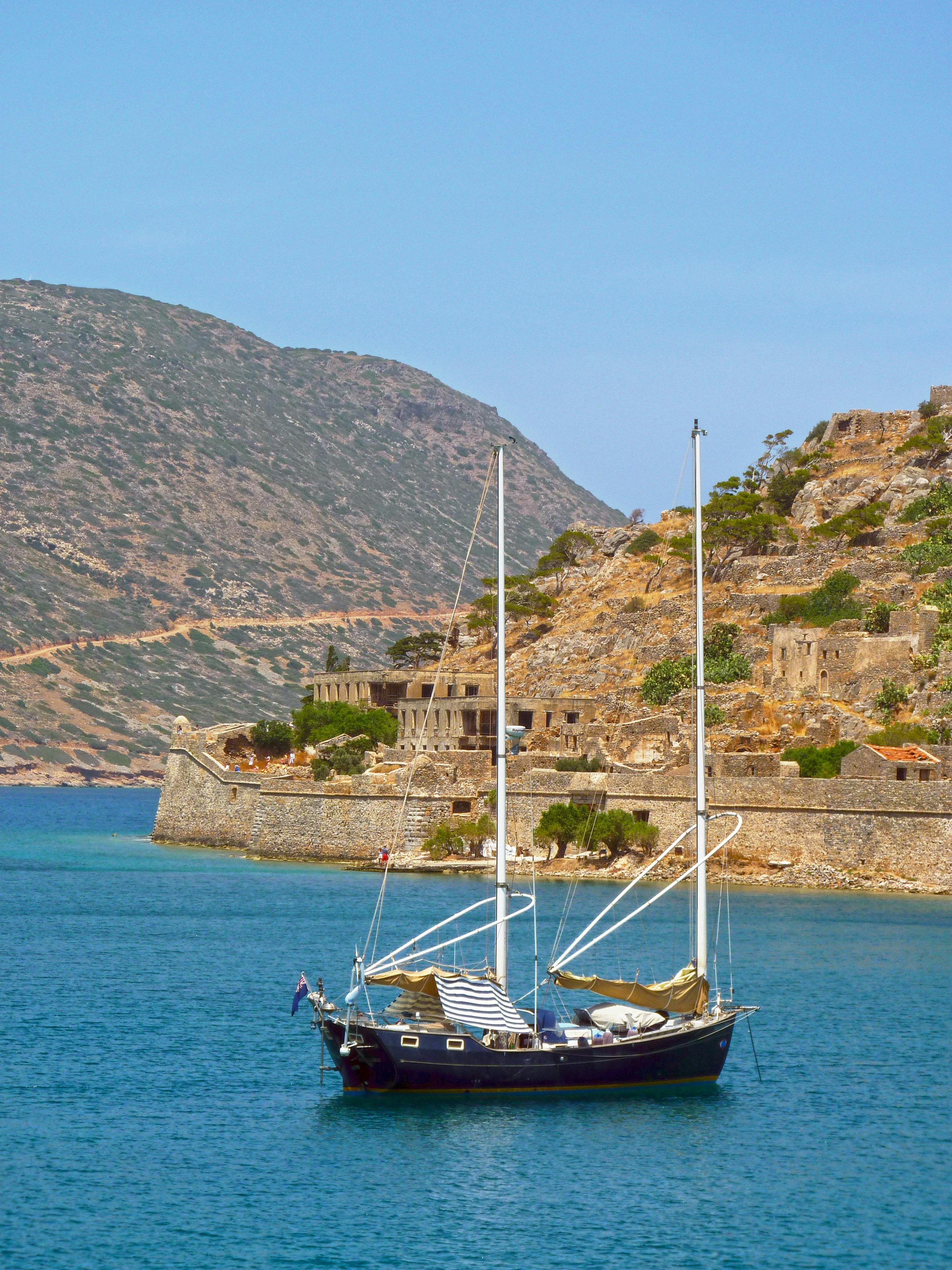 Brown Boat on Sea Near Mountain · Free Stock Photo