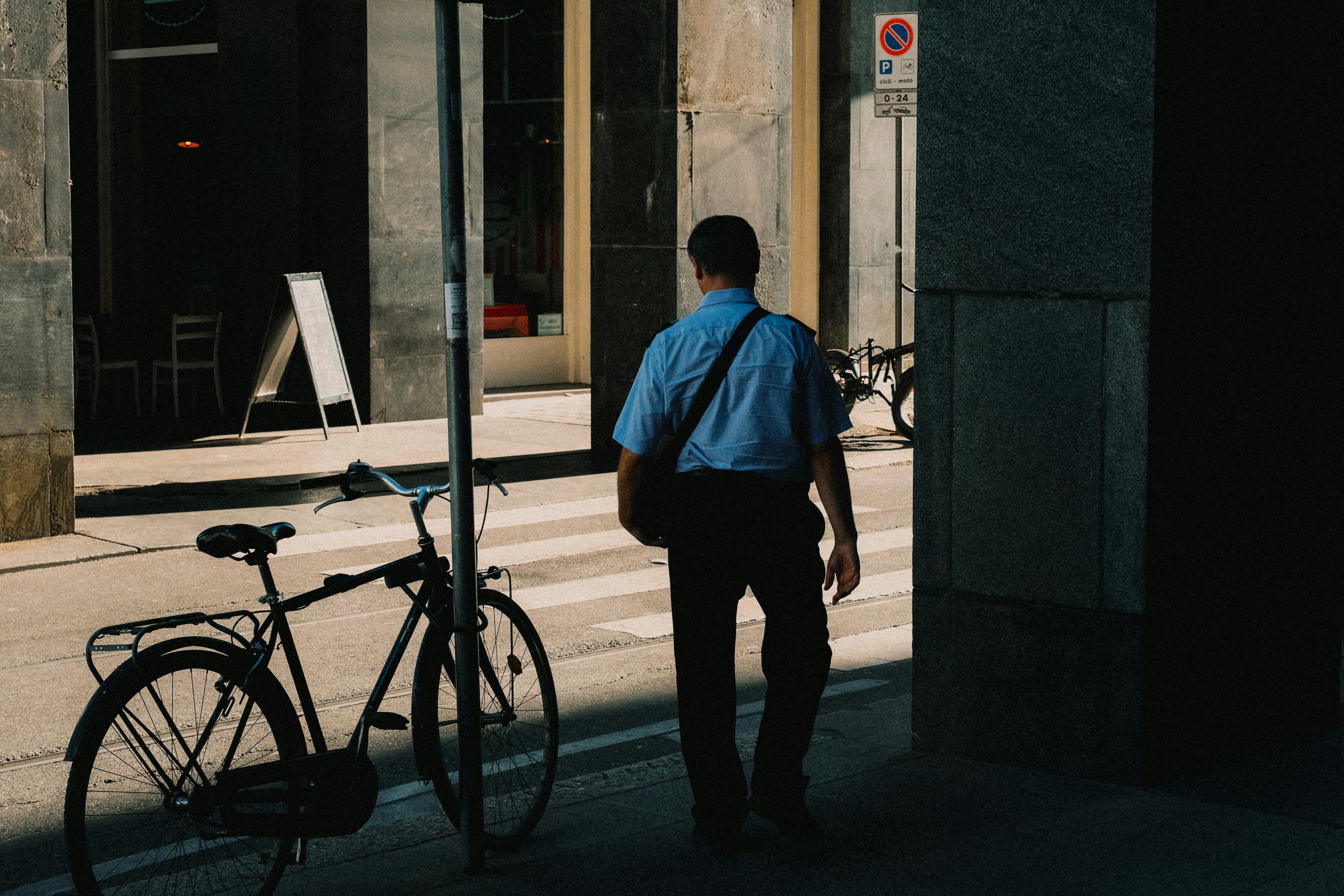 Back View of a Man Walking on the Sidewalk · Free Stock Photo