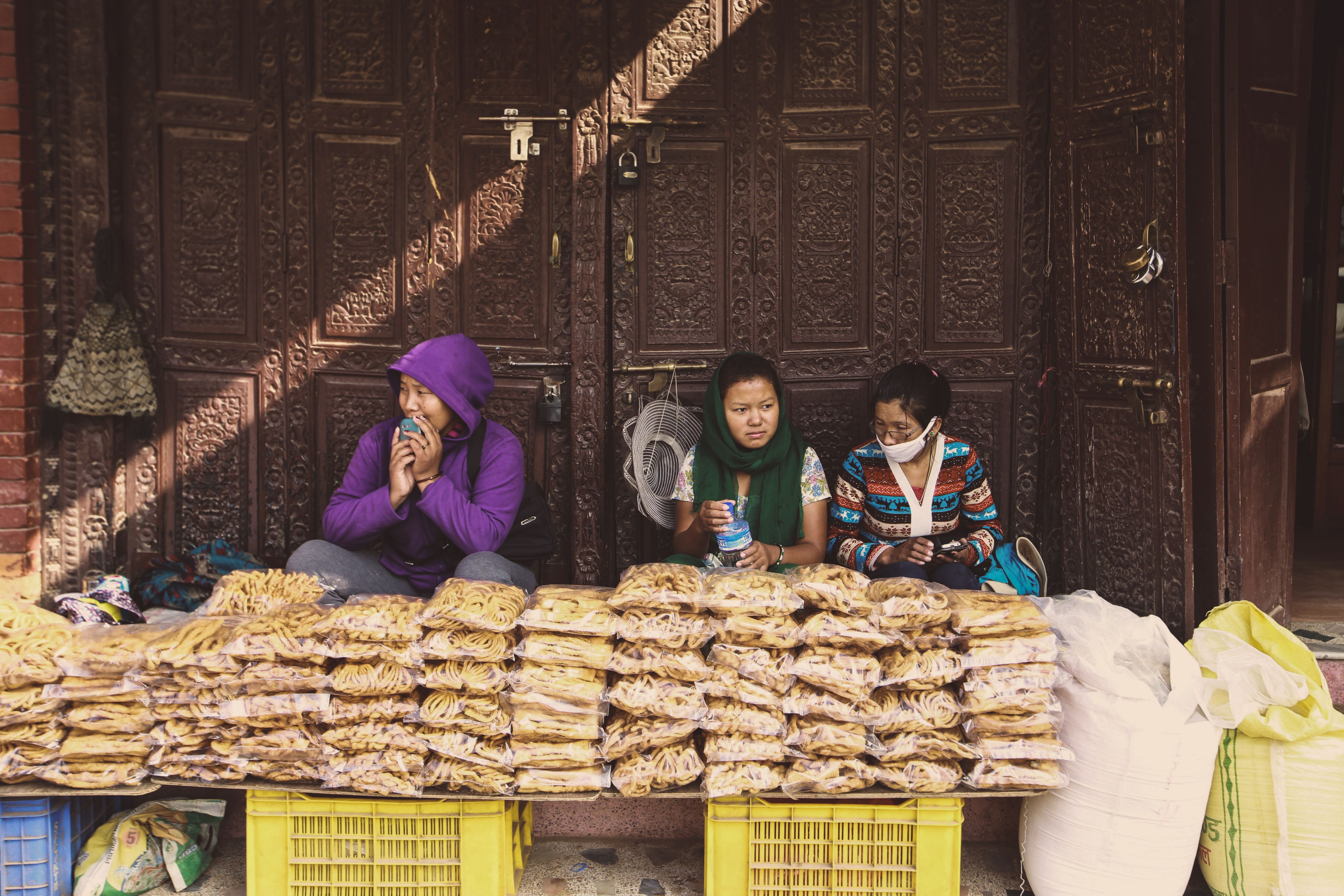 A Vendor Sitting in a Food Stall · Free Stock Photo