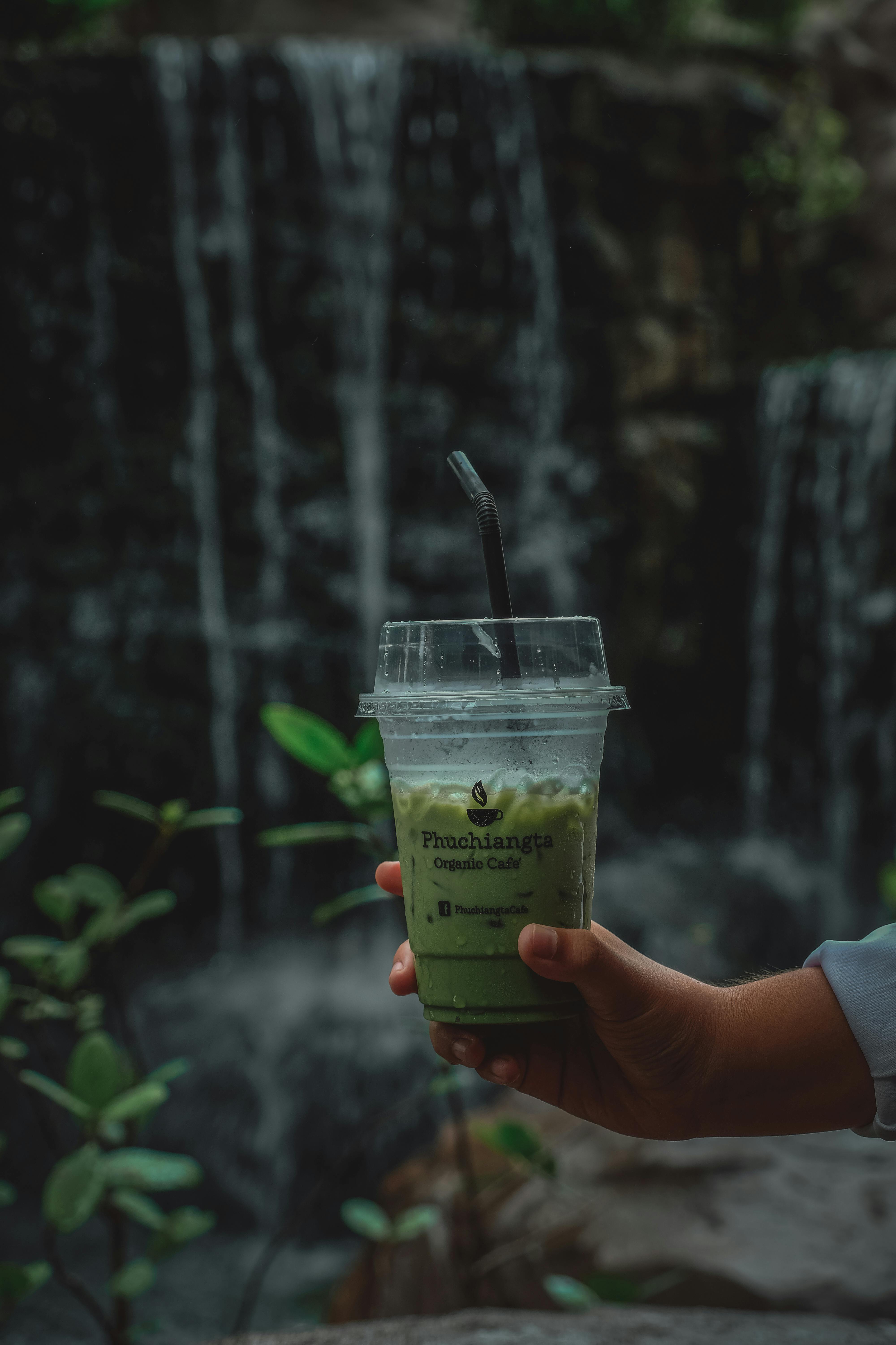 Woman Drinking Matcha and Watching a Cartoon · Free Stock Photo