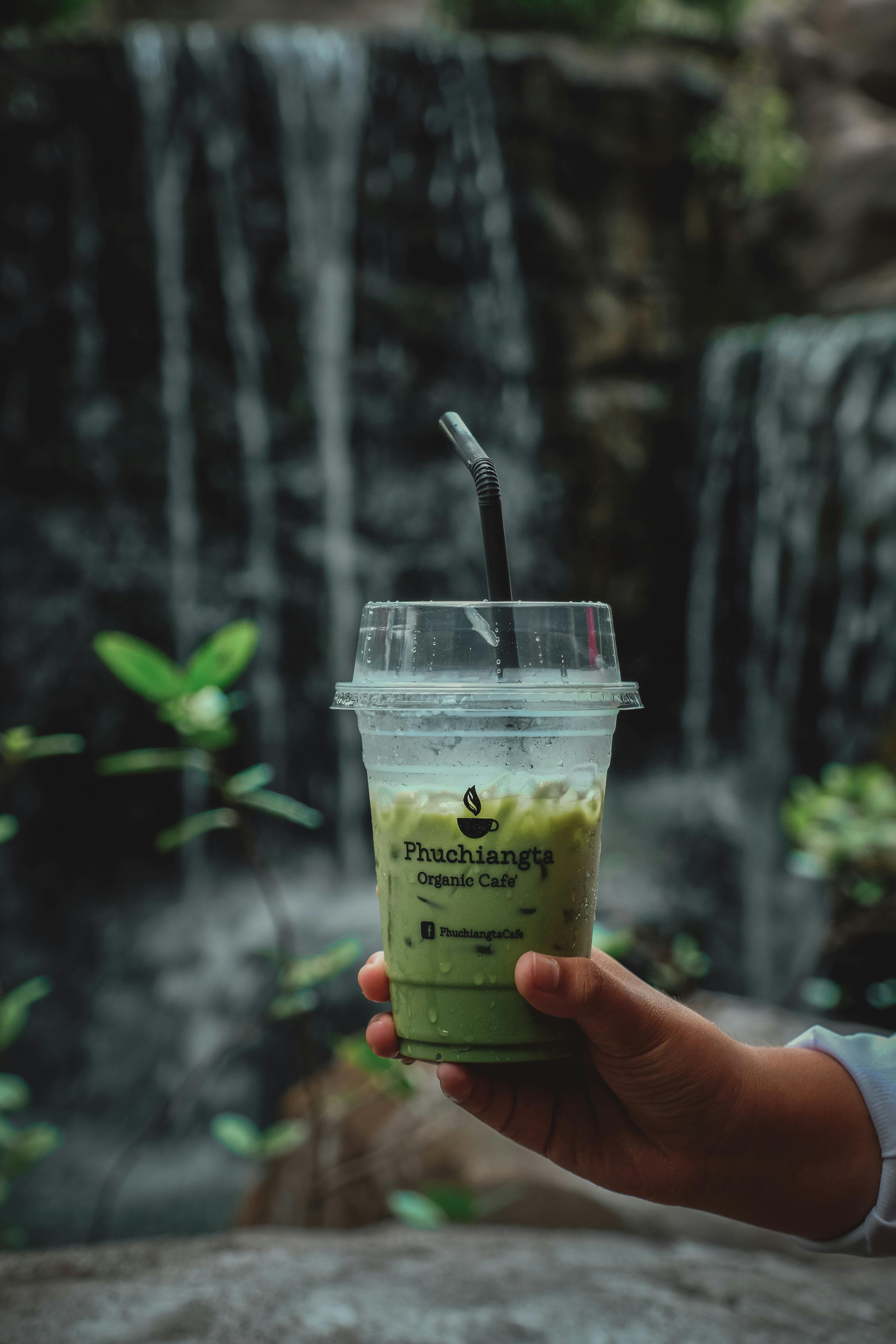 Disposable Plastic Cups of Milkshake on Green Grass · Free Stock Photo