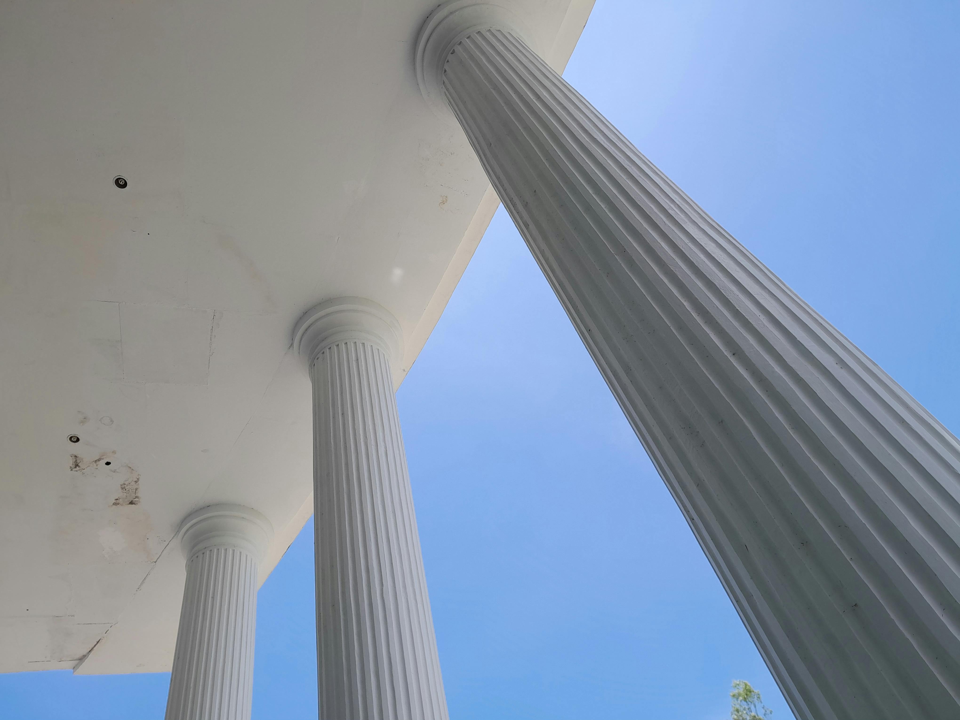 Grayscale Photo of Concrete Pillars · Free Stock Photo