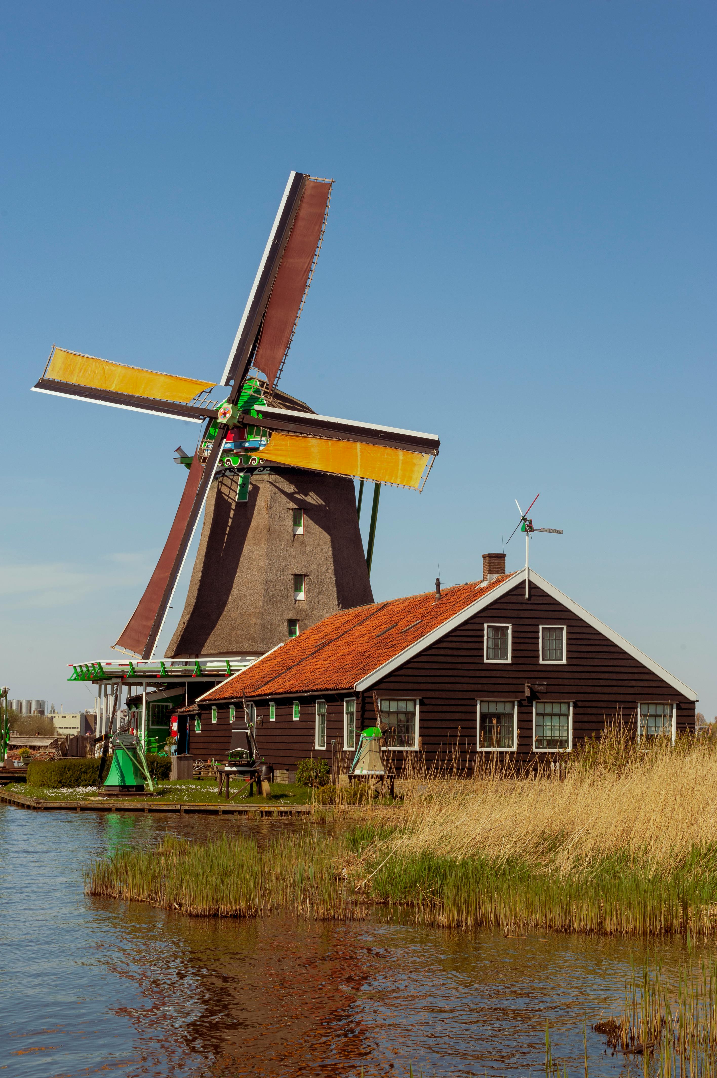Green and Brown Windmill Beside the Lake · Free Stock Photo