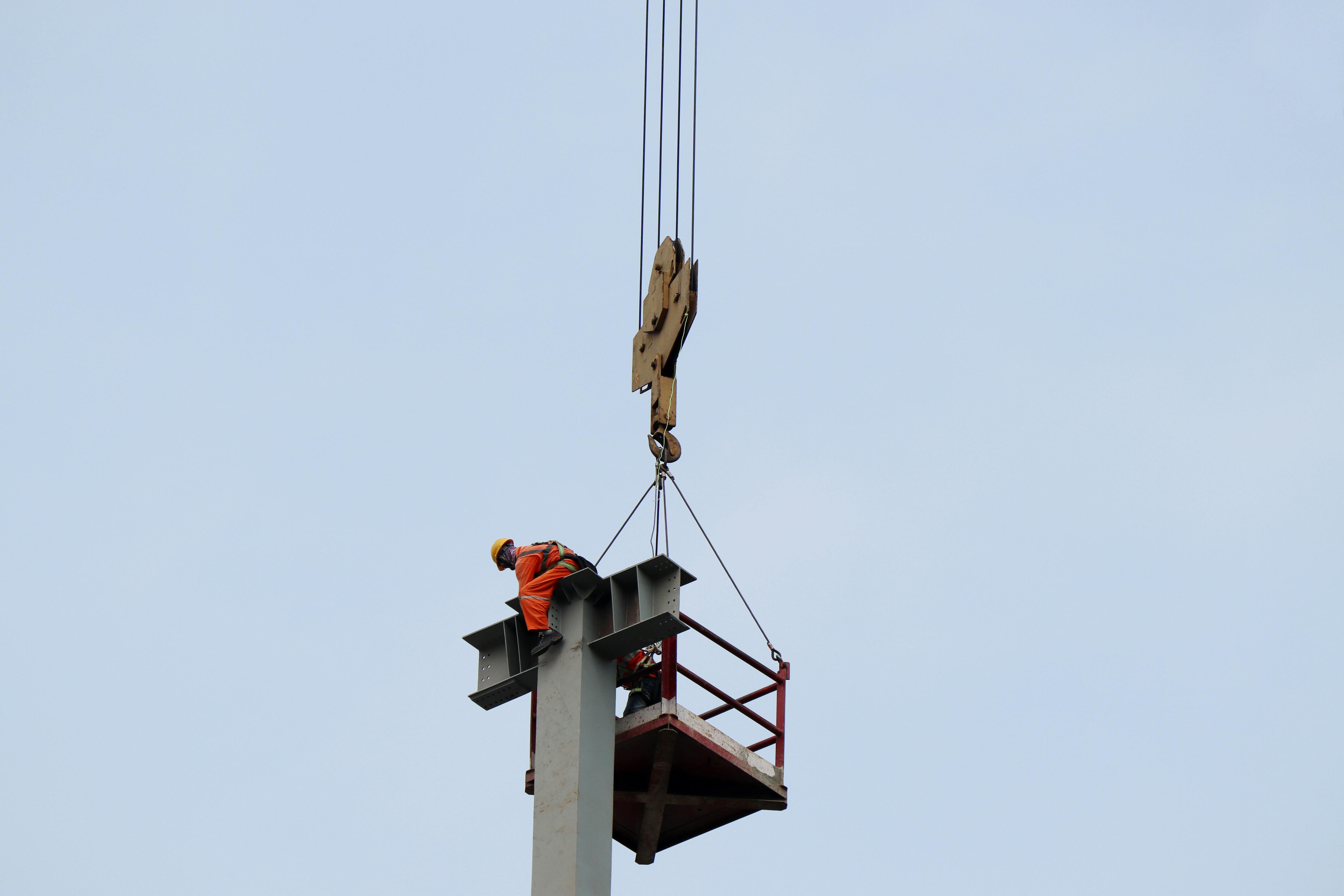 Construction Workers Working Under Blue Sky · Free Stock Photo