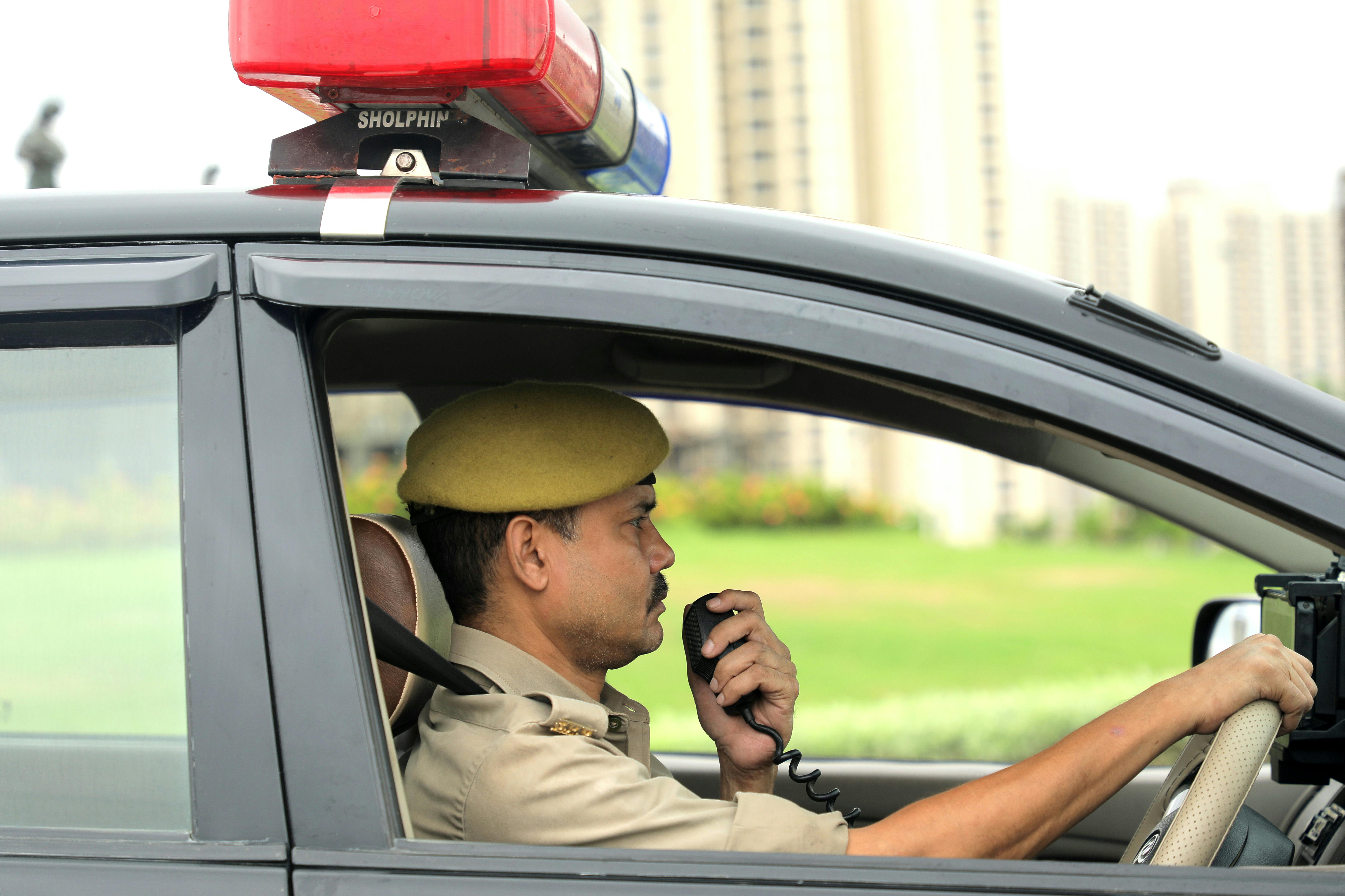Close-Up Photo of a Police Officer Wearing Sunglasses · Free Stock Photo