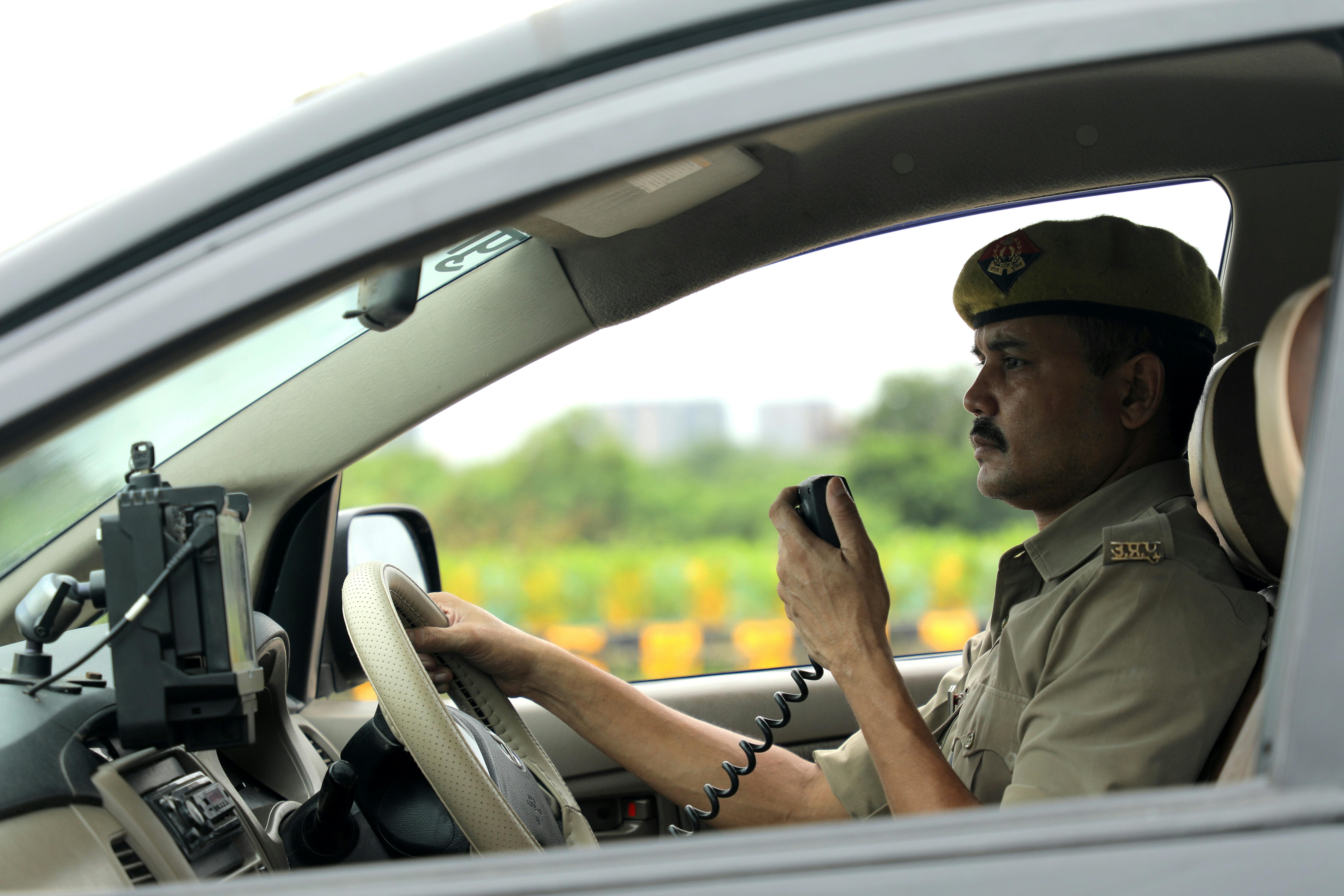 A Police Officer Using a Communication Radio · Free Stock Photo