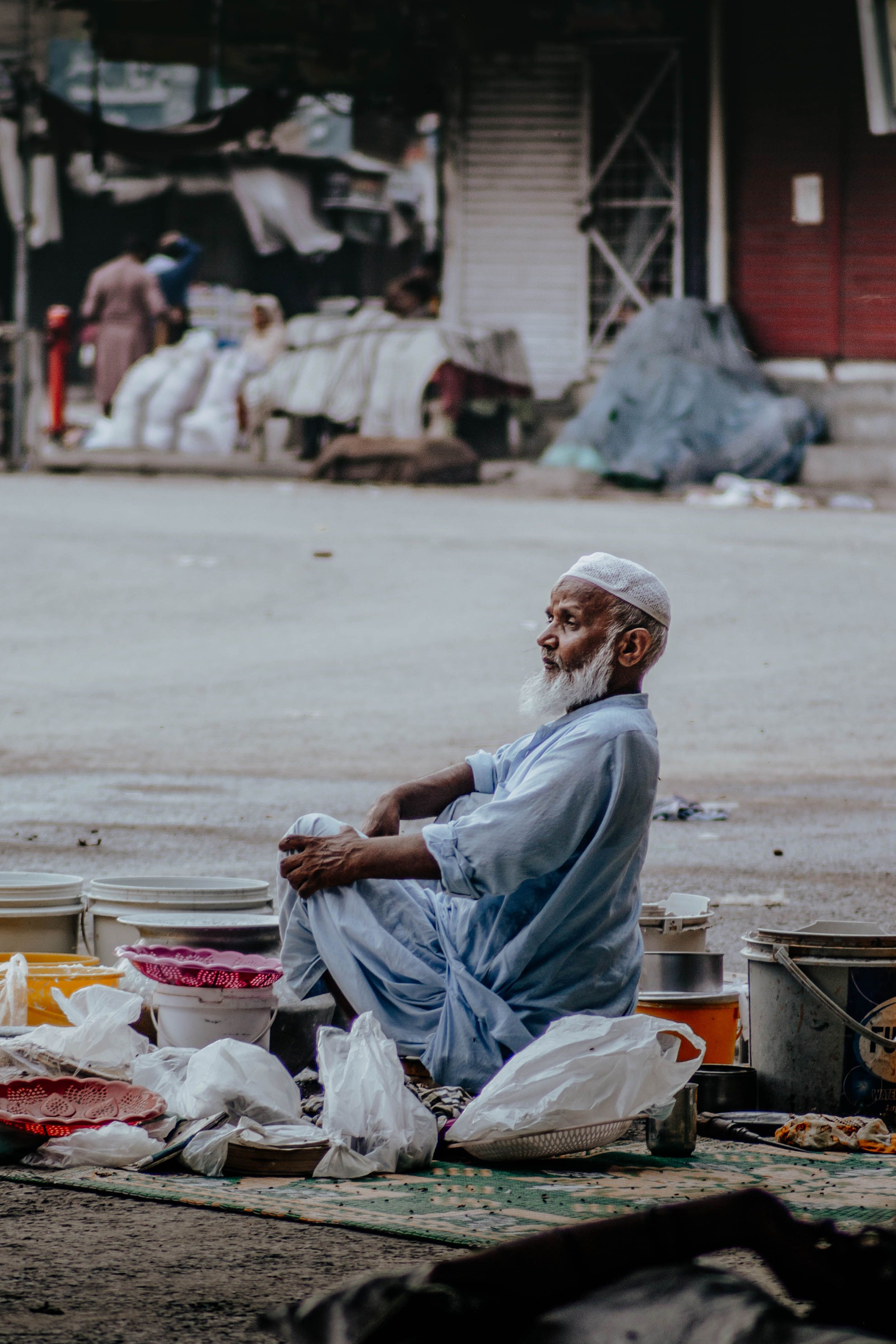 Street Vendor Sitting on the Street · Free Stock Photo