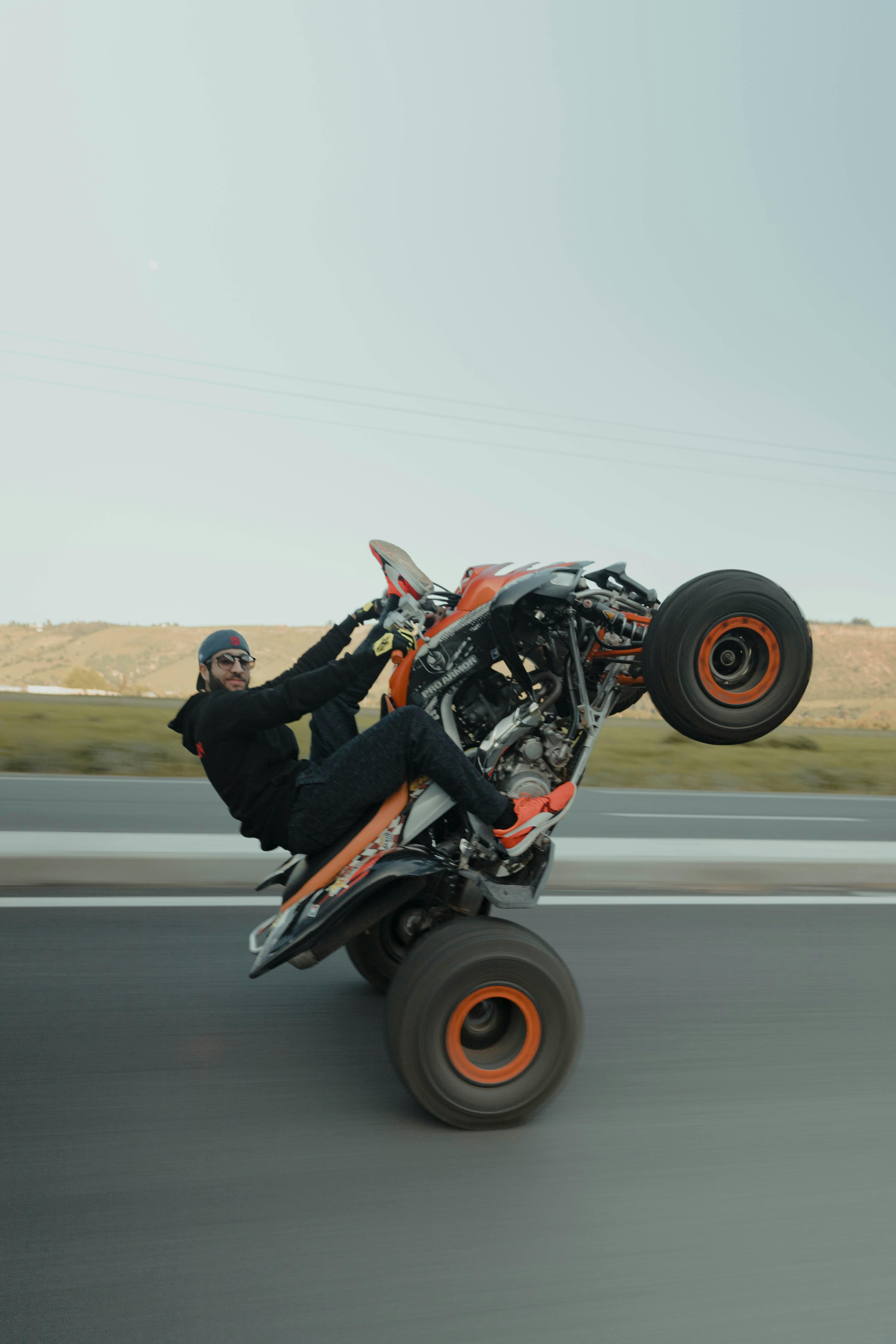 Man Riding on a Quad Bike Doing Wheelie · Free Stock Photo