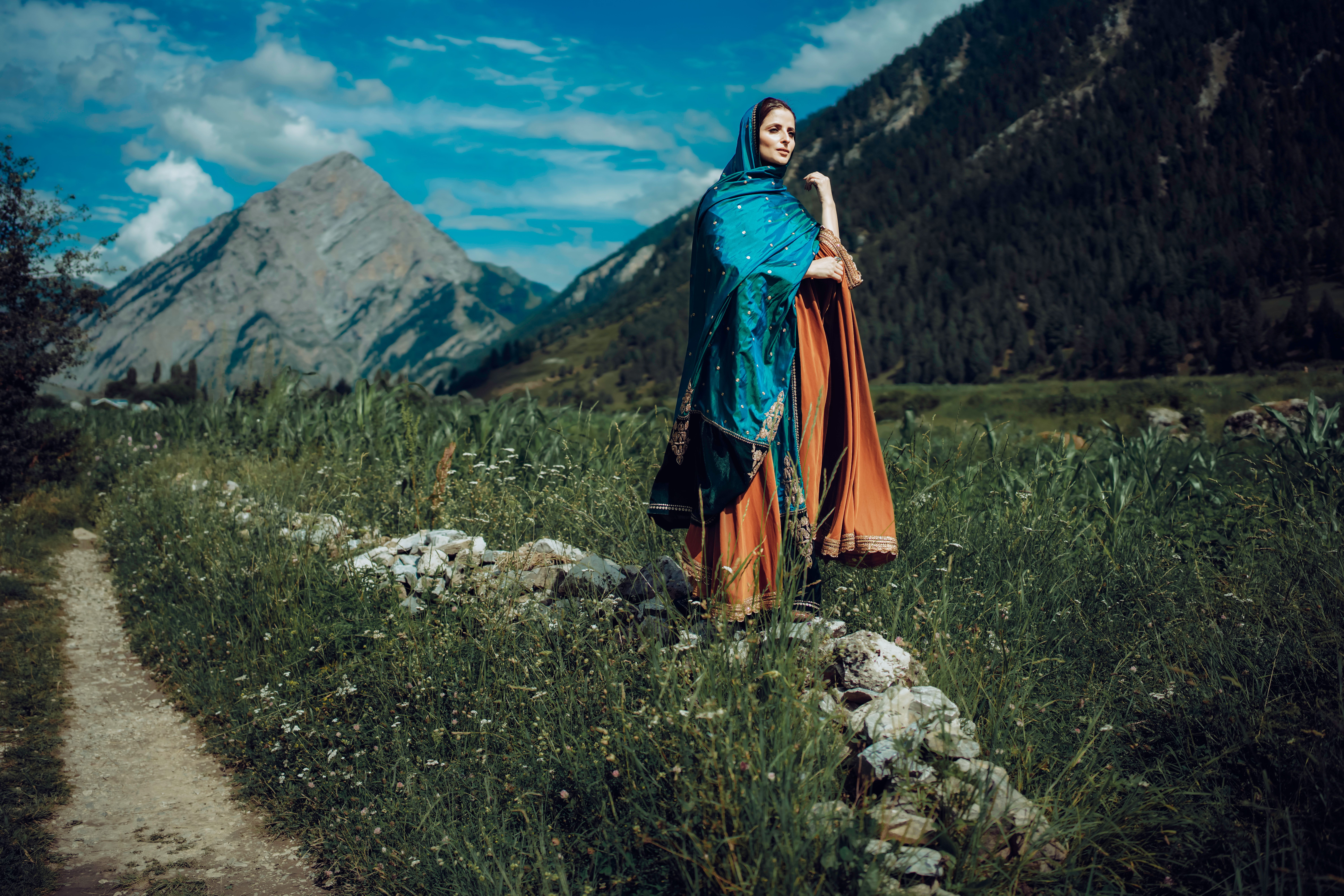 A Woman in a Sari Standing in the Countryside · Free Stock Photo
