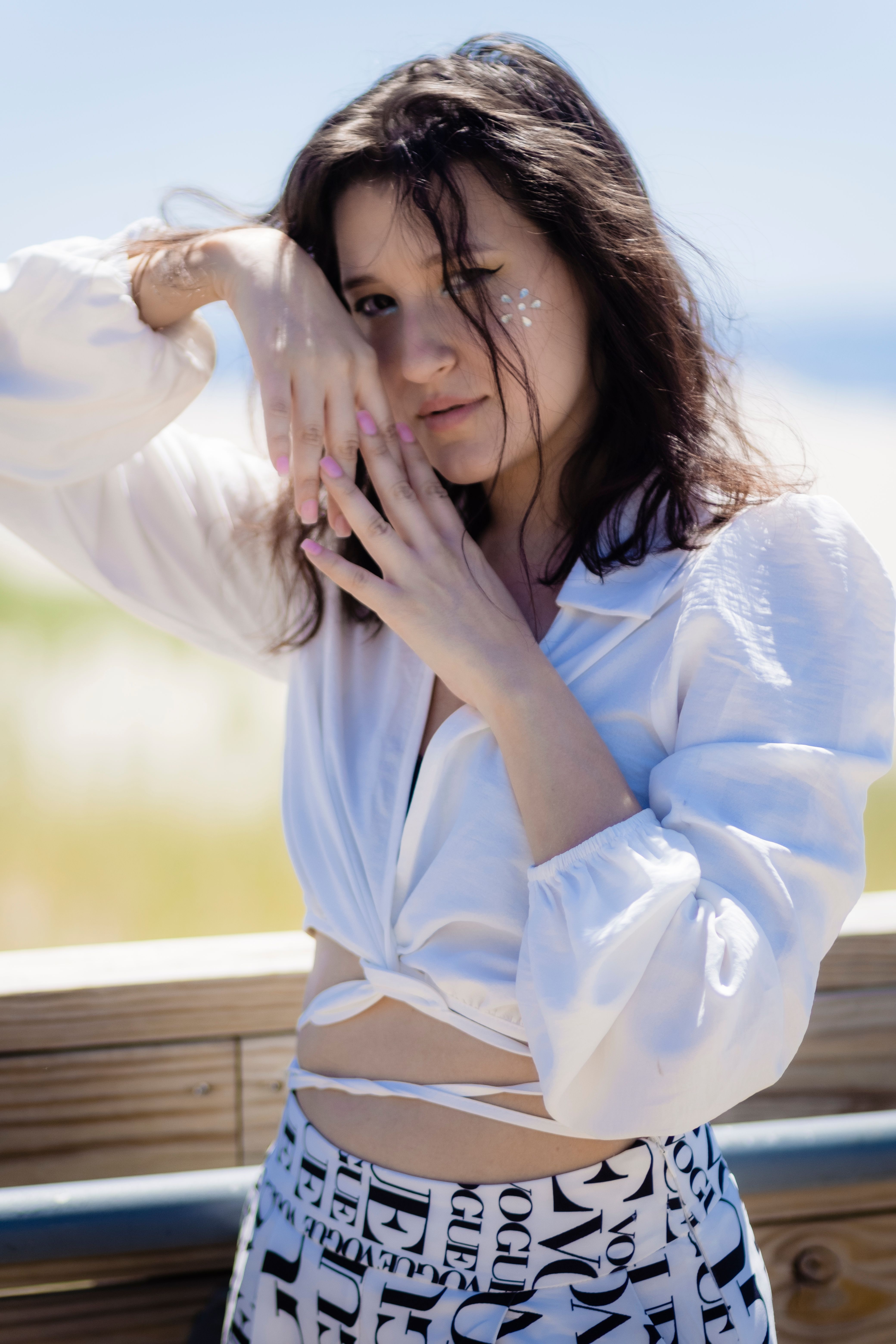 A Woman Posing While Her Hands near Her Face · Free Stock Photo
