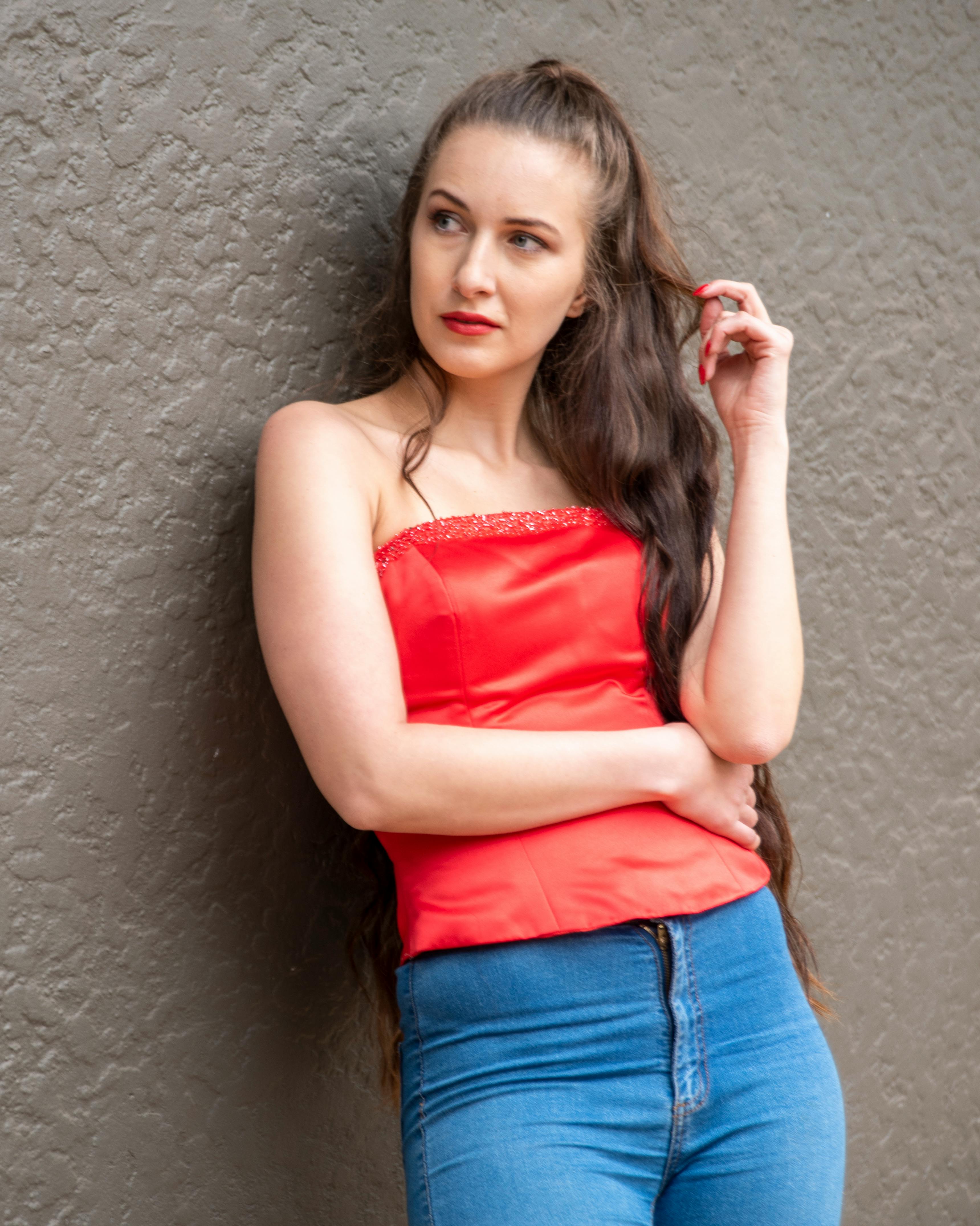 A Woman in Tube Top and Denim Jeans · Free Stock Photo