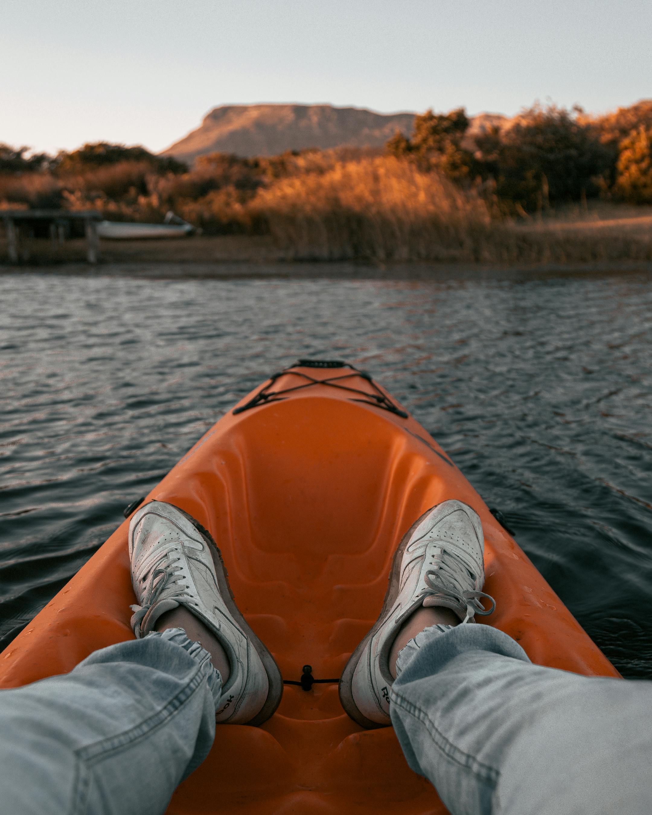 Outstretched Legs of Person Swimming in Canoe · Free Stock Photo