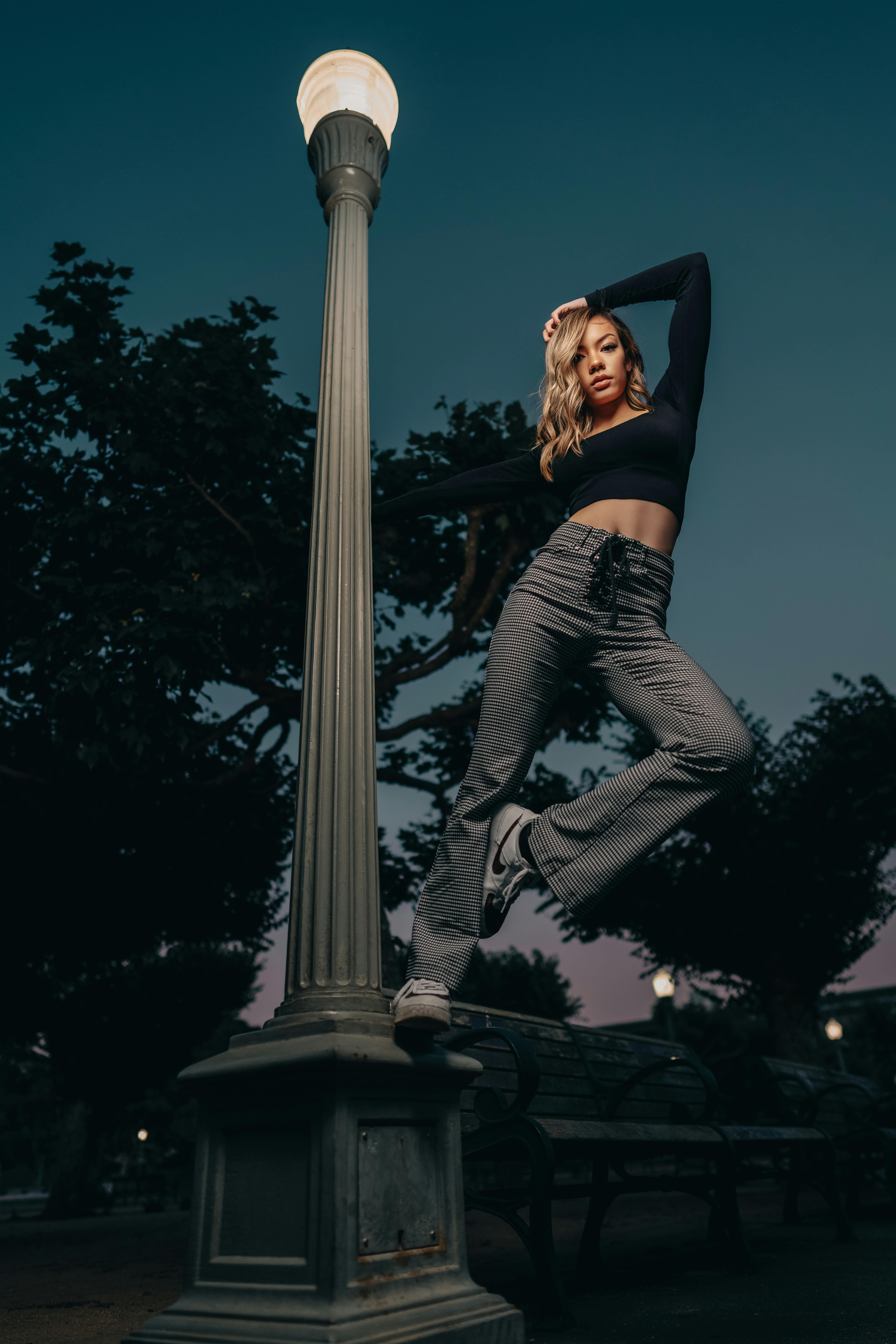 Woman Posing by Street Lamp at Dusk · Free Stock Photo