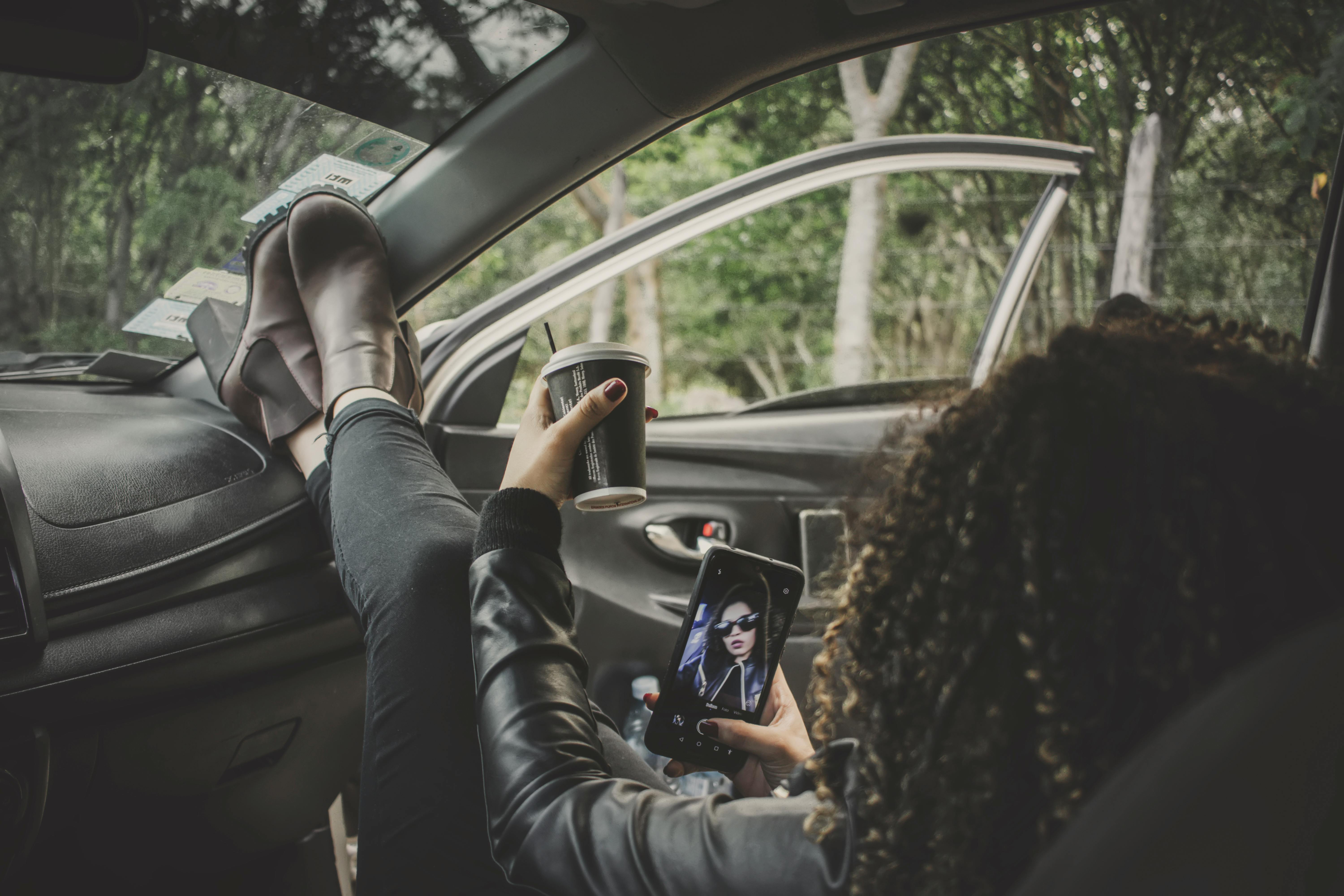 A Woman Sitting Inside the Car while Taking Selfie · Free Stock Photo