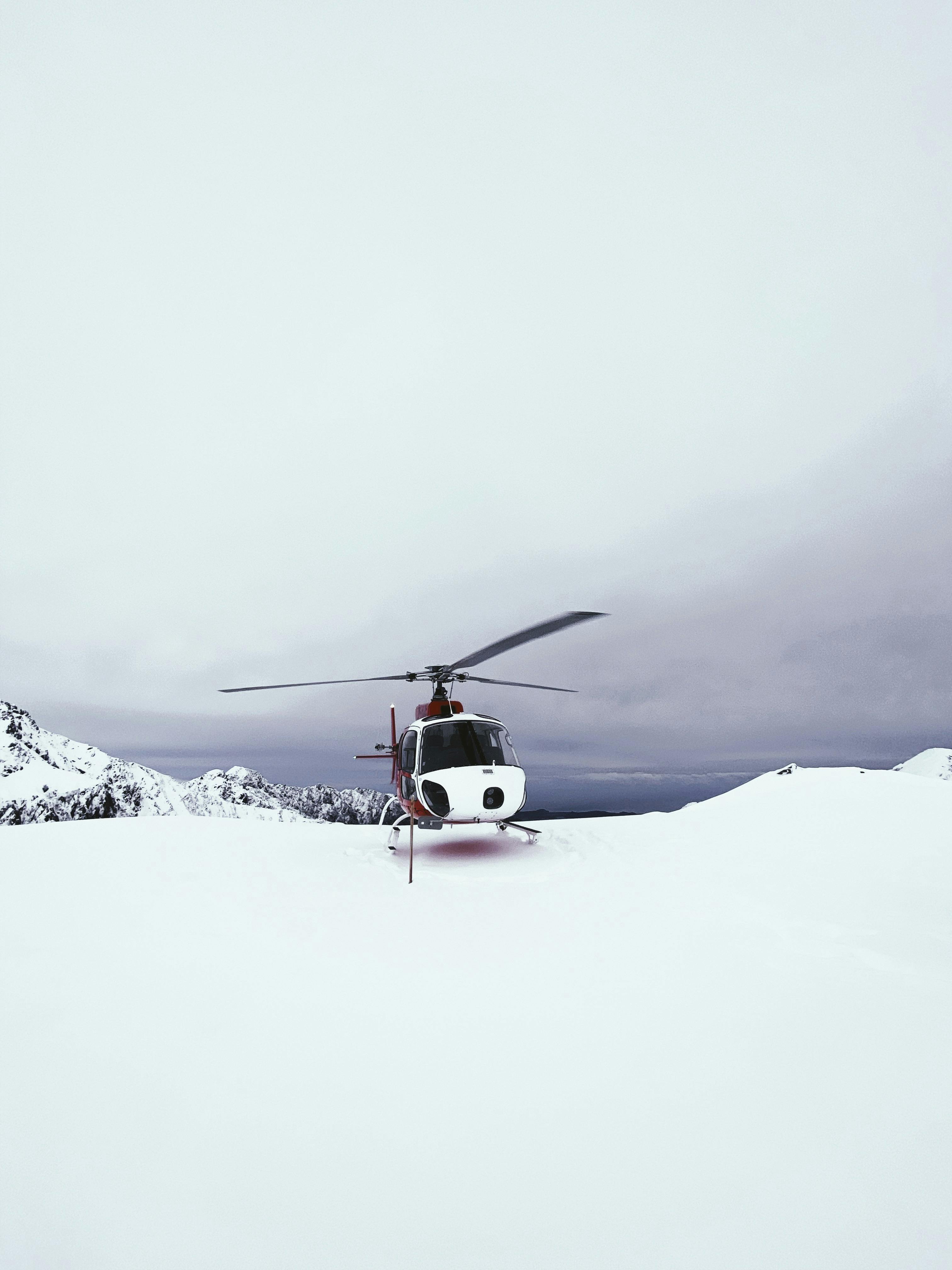 White and Red Helicopter on Snow Covered Ground · Free Stock Photo