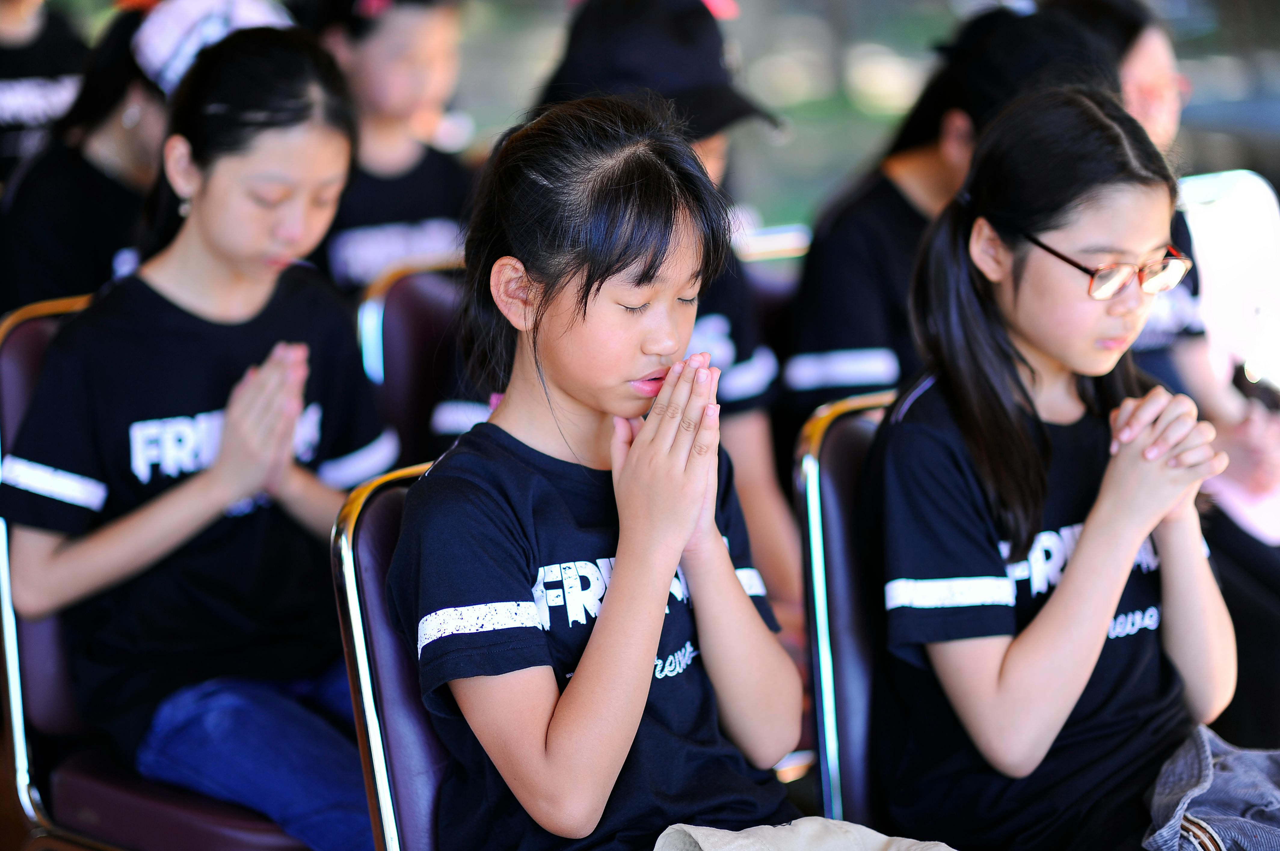 Girls in Black and White Shirt Praying Together · Free Stock Photo