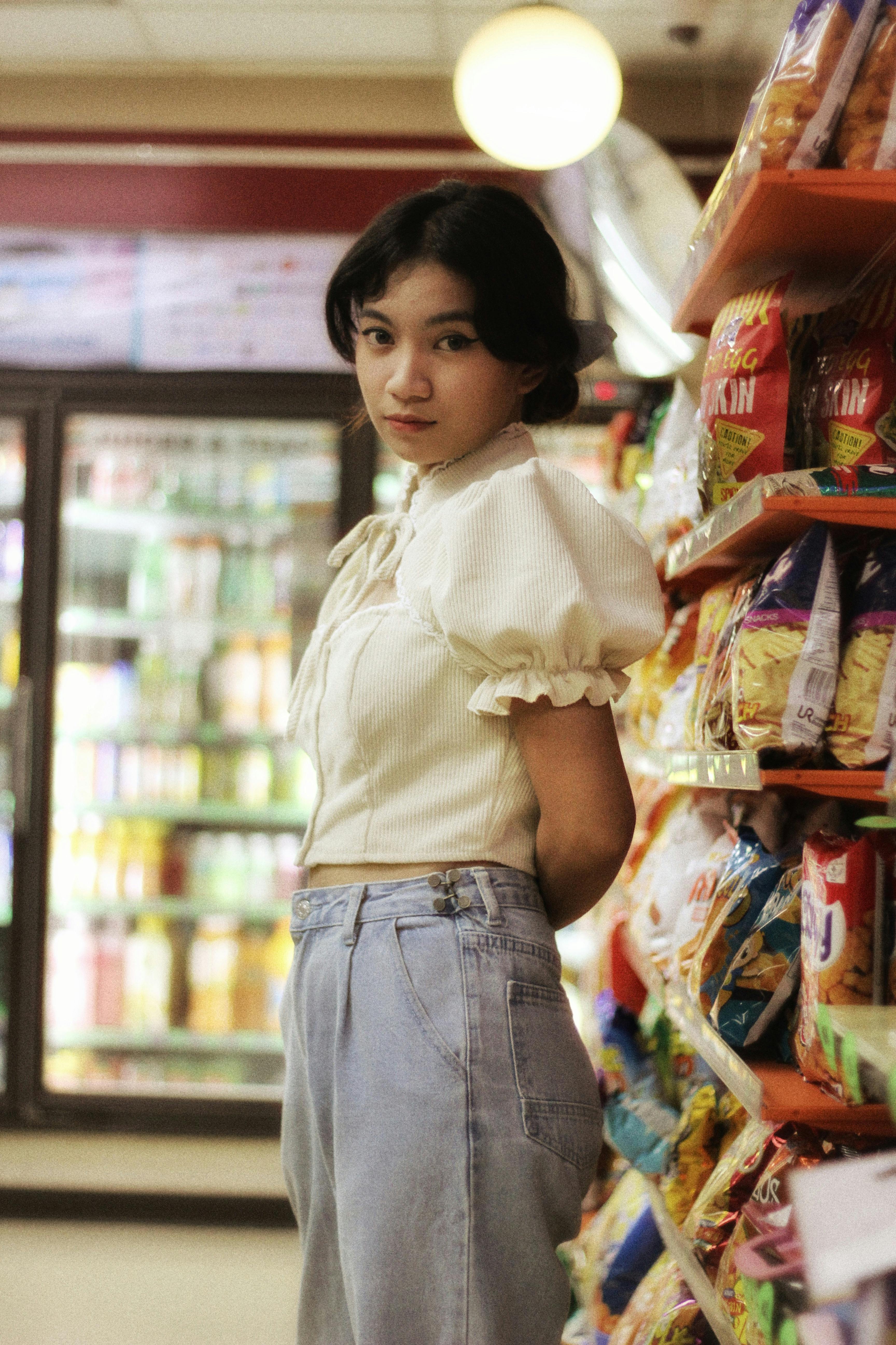 Woman in White Blouse Standing Inside a Grocery · Free Stock Photo