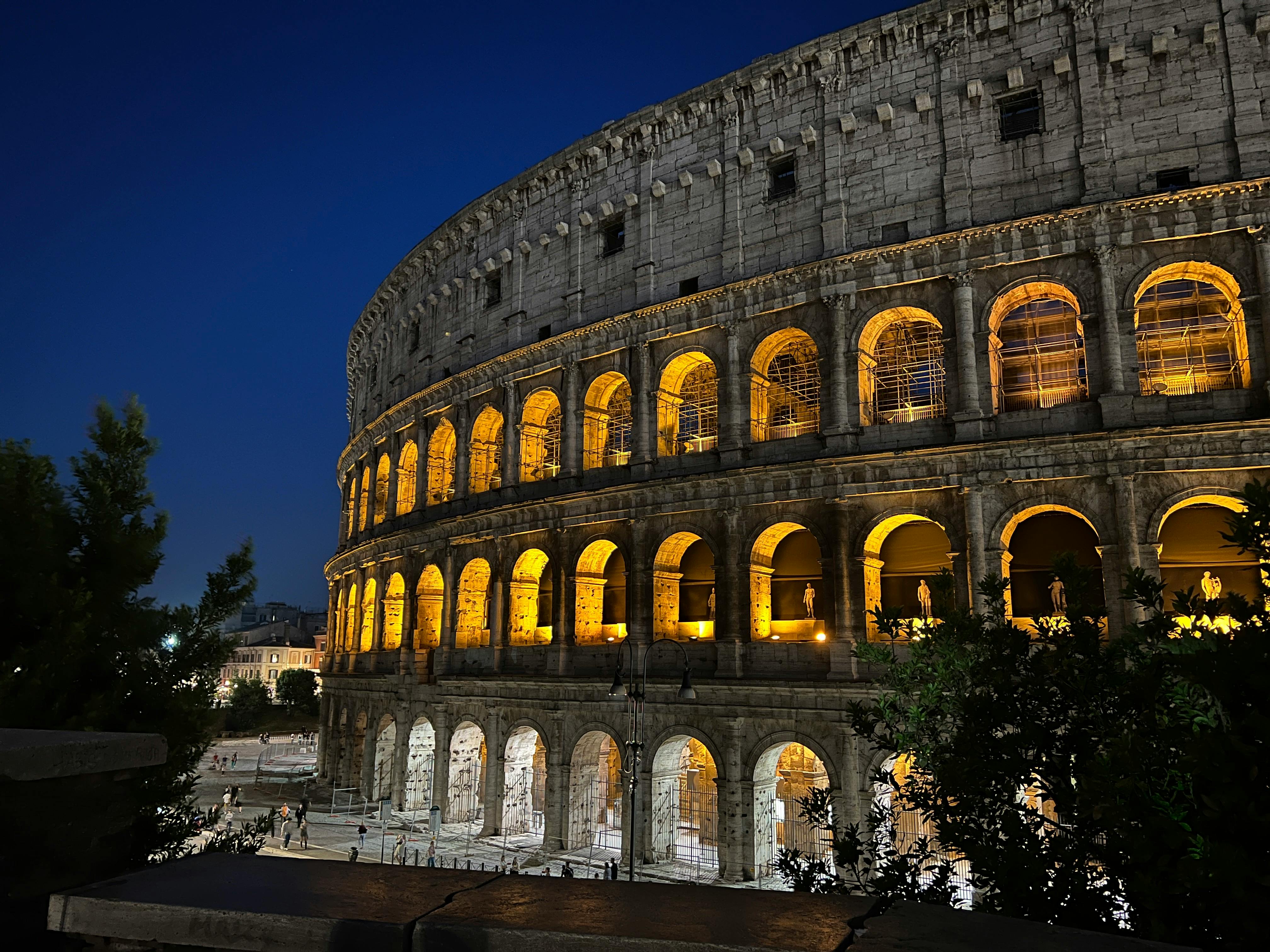 A Colosseum with Lights at Night · Free Stock Photo