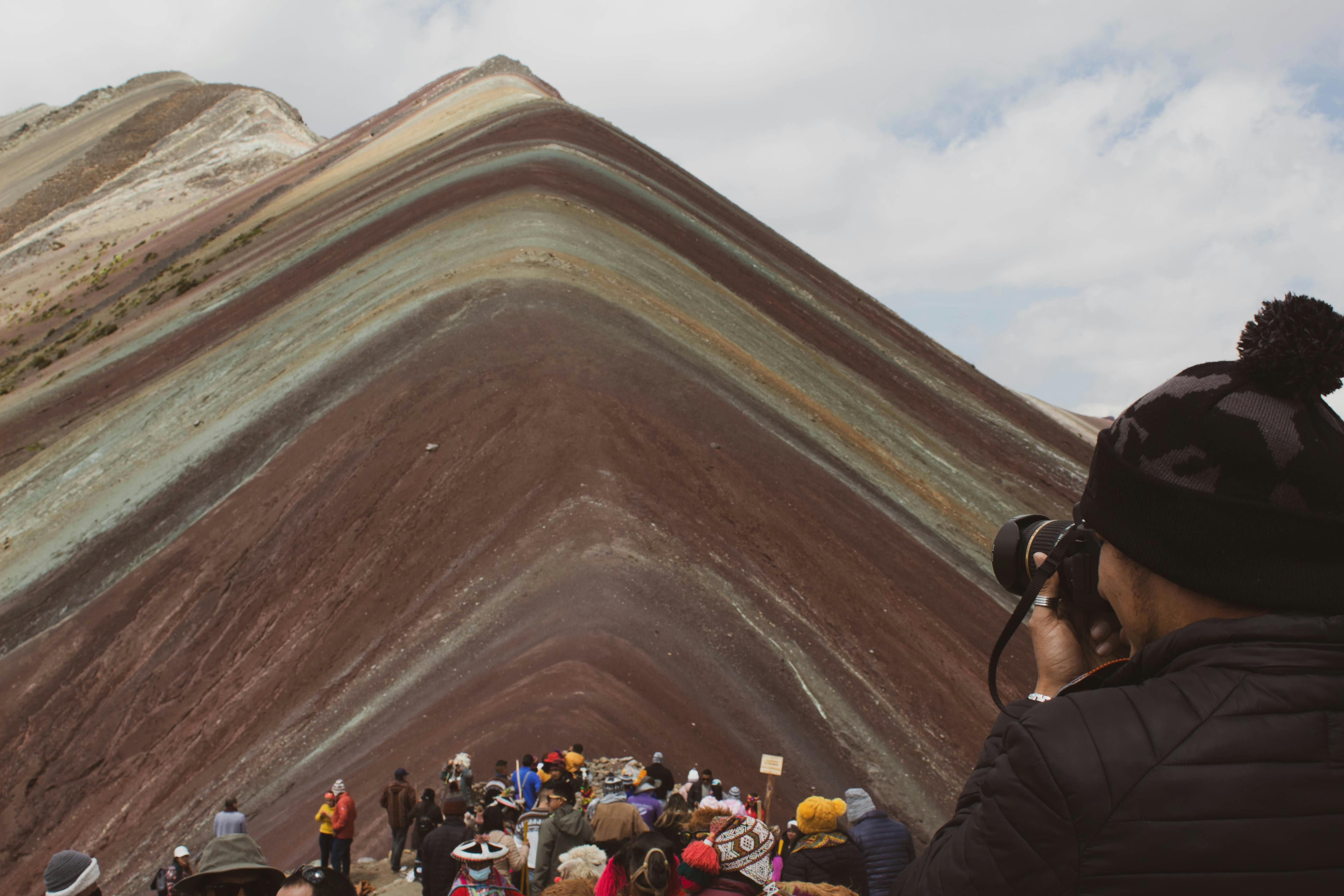 A Photographer Taking A Picture Of The Vinicunca Mountain Free Stock