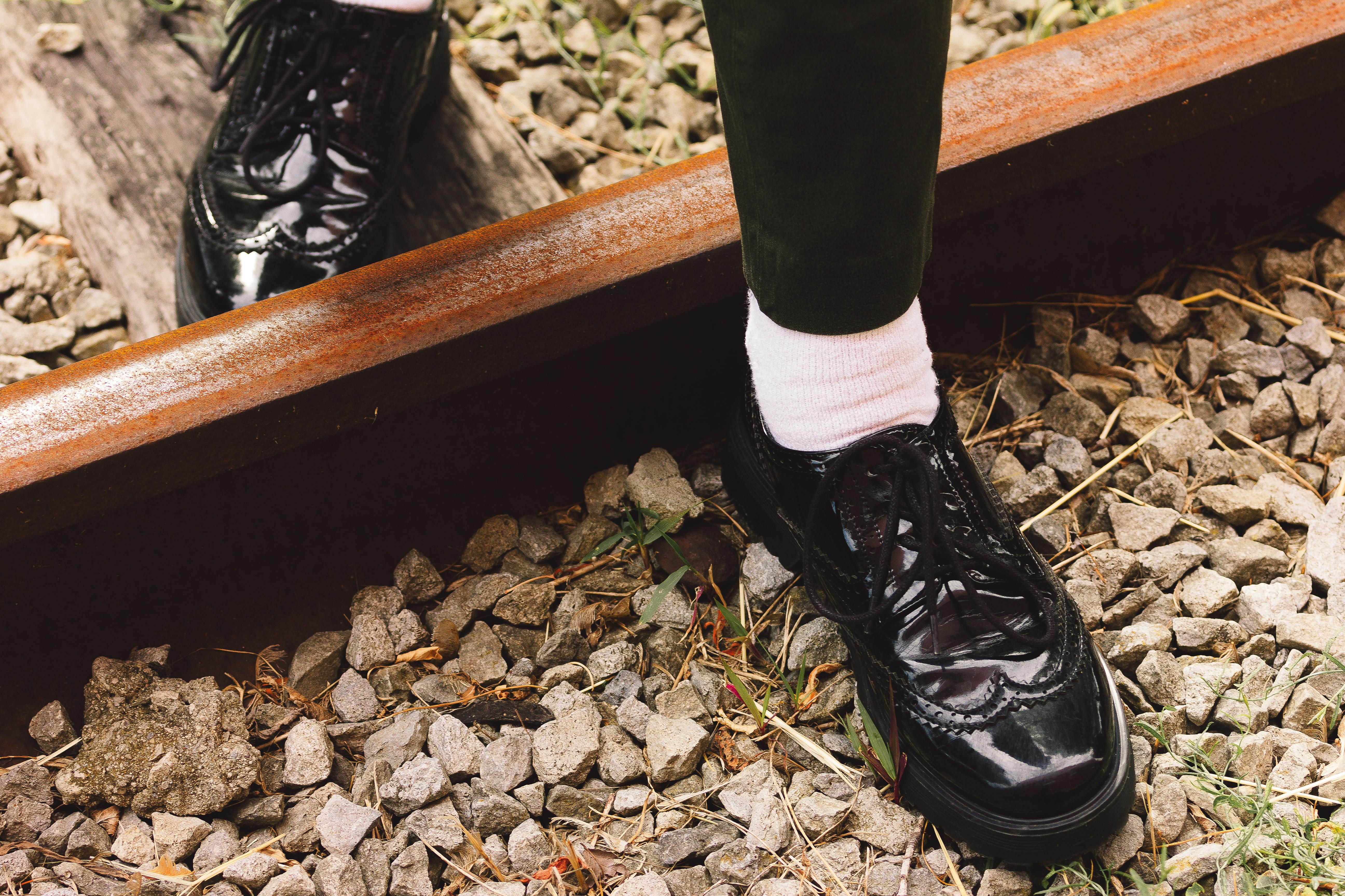 Close-up of Leather Shoes Stepping on Rocks · Free Stock Photo