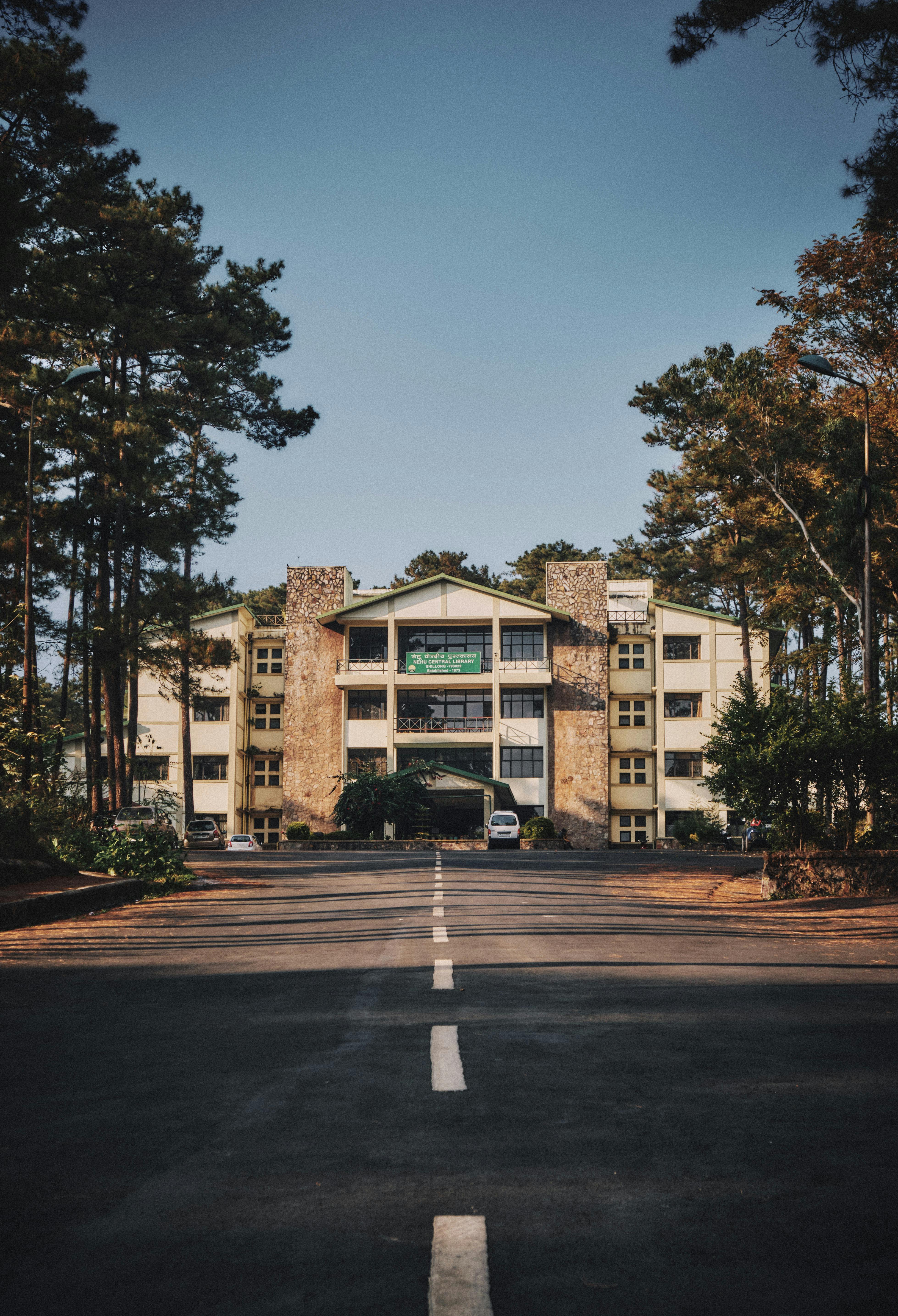 A Nehu Central Library Between Green Trees · Free Stock Photo