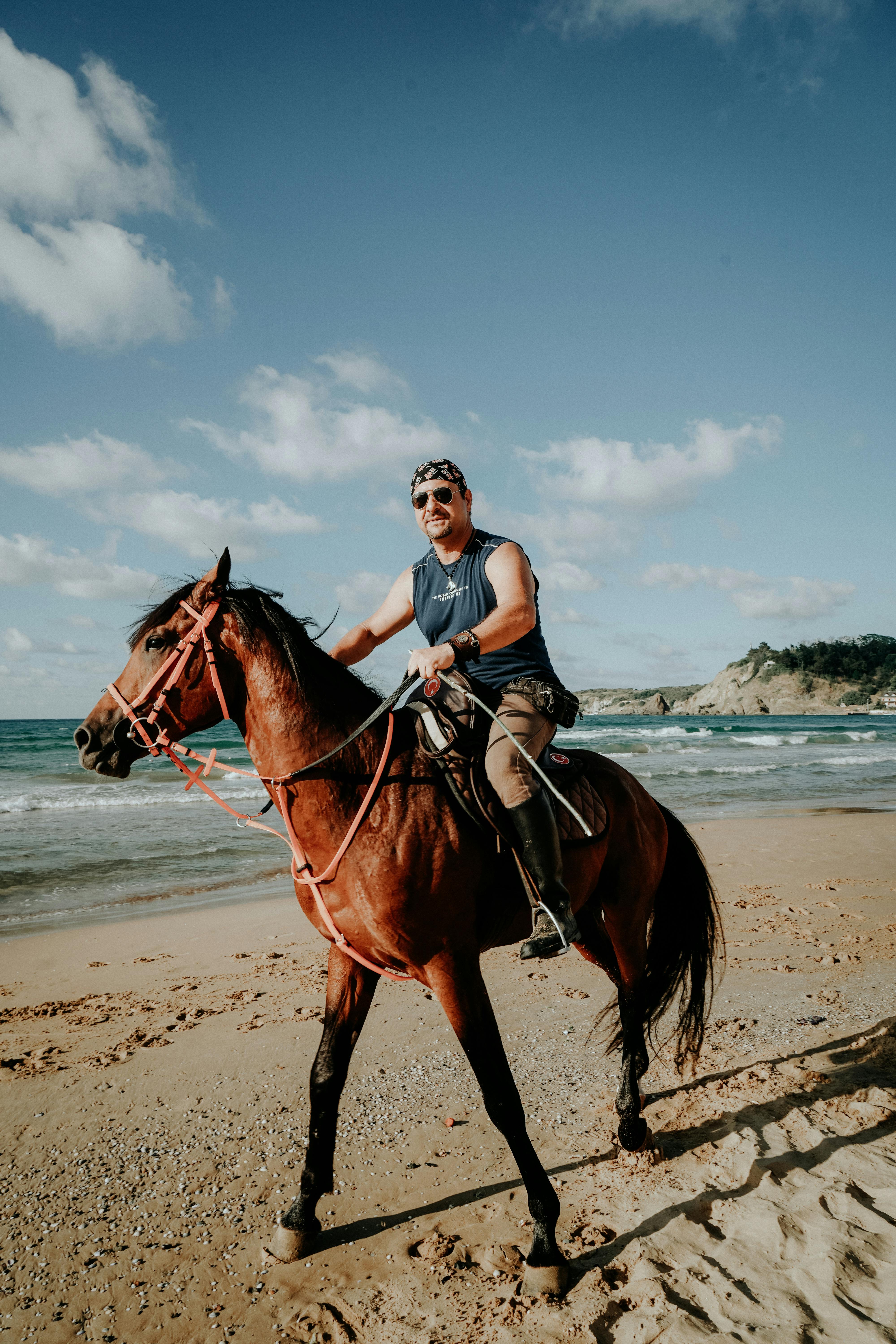 A Man Riding a Horse at the Beach · Free Stock Photo