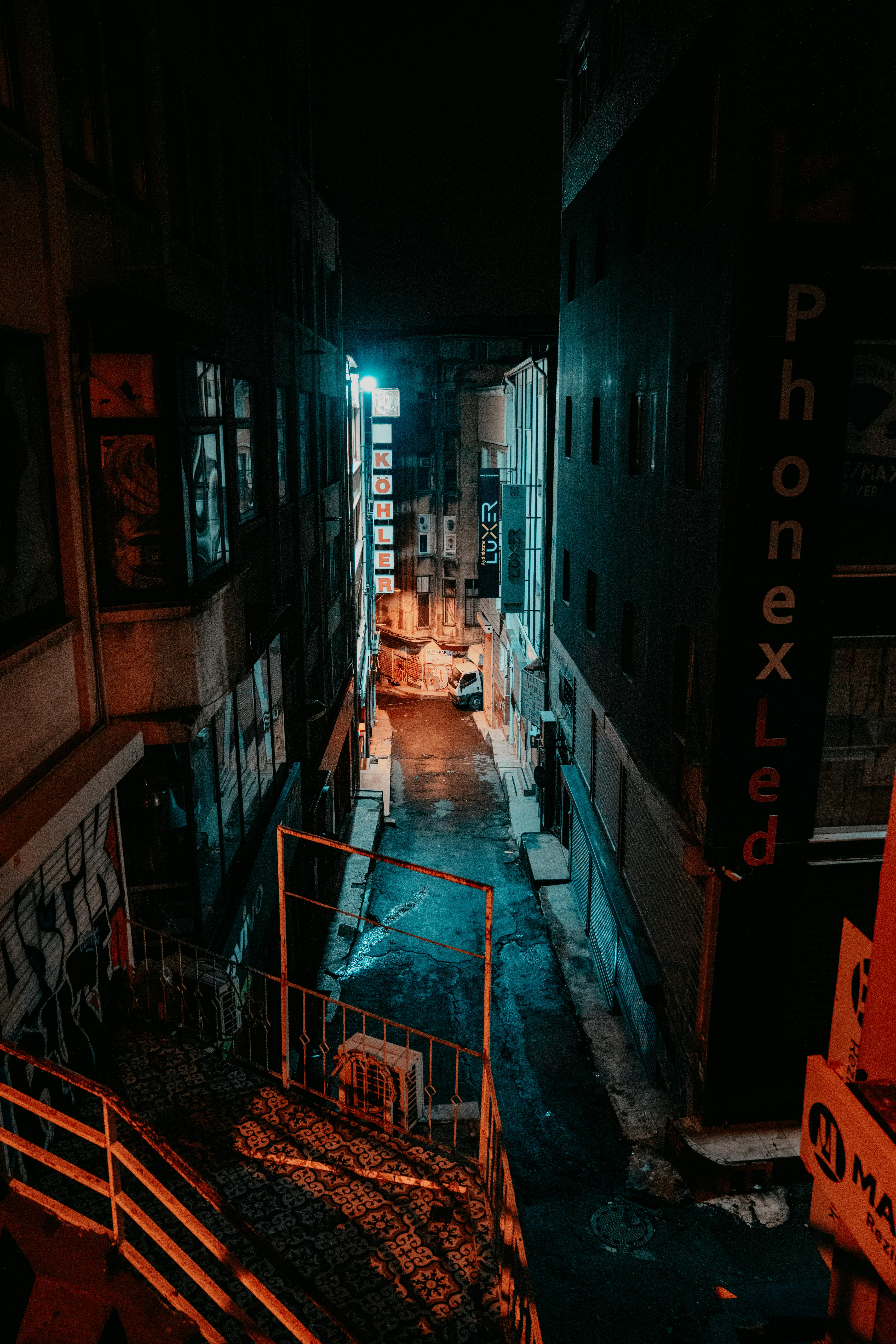 An Empty Street at Night Between Buildings · Free Stock Photo